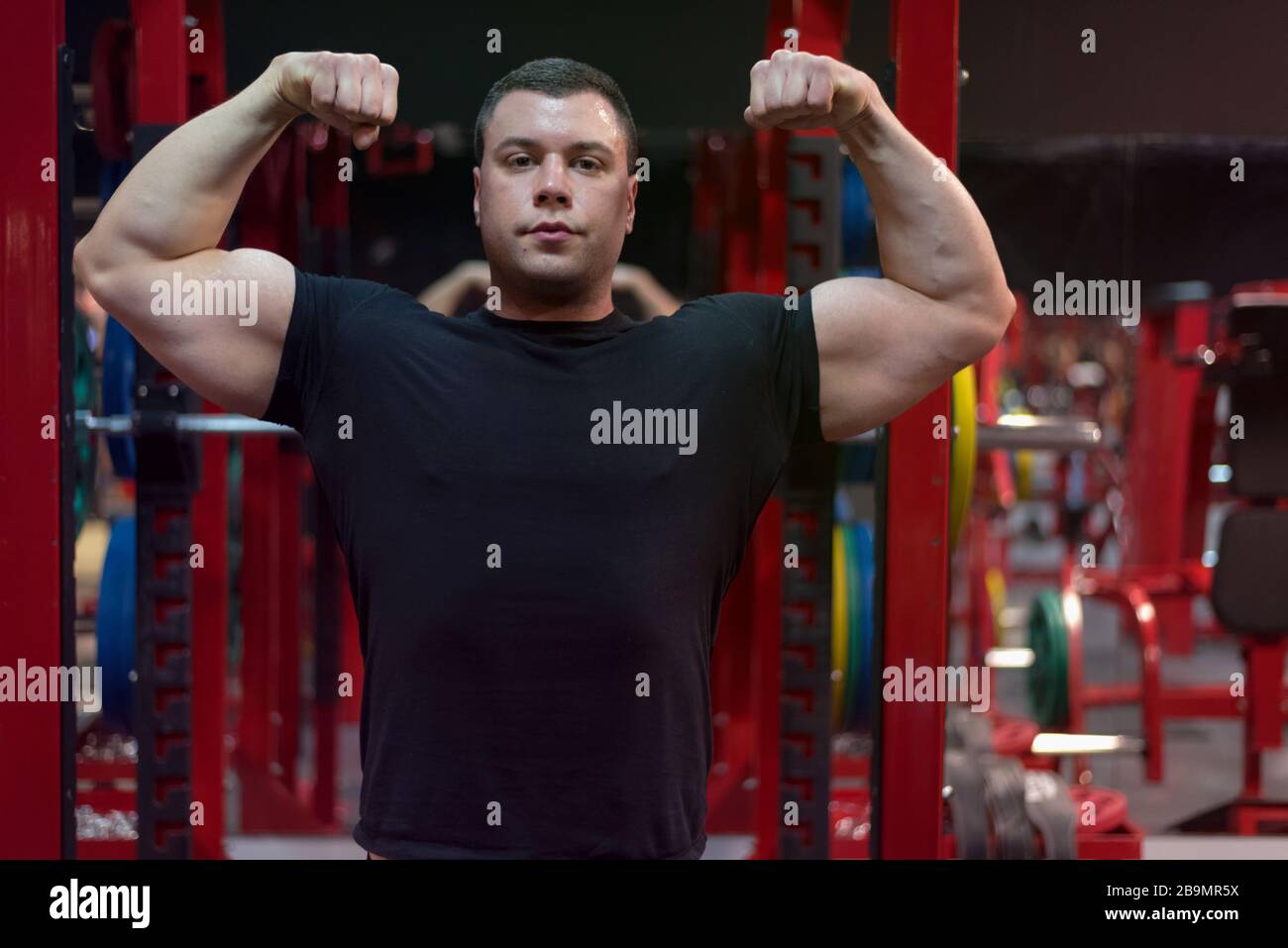 Fitness model Man posing in the gym. Handsome man with big muscles ...