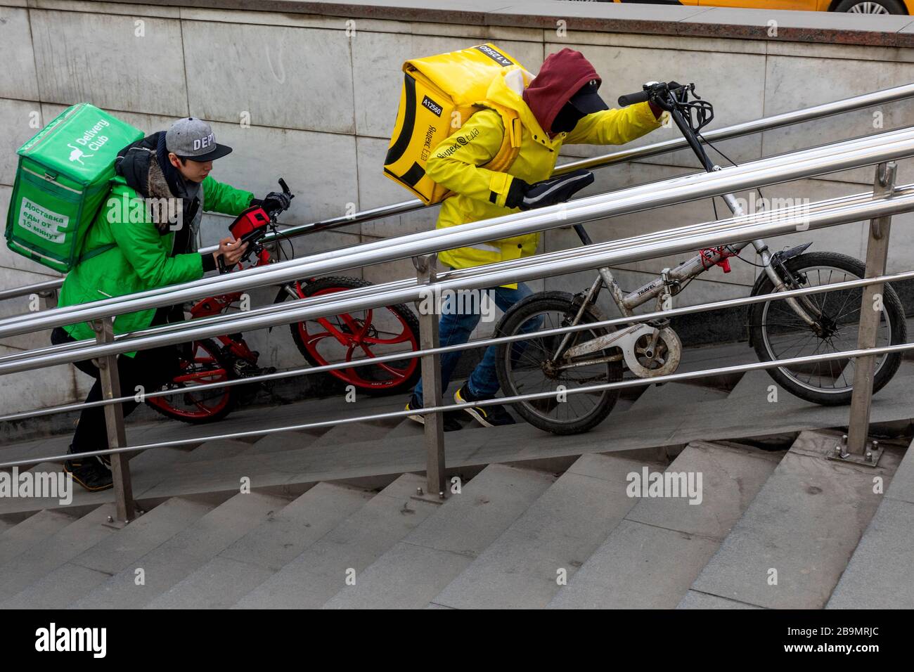 Couriers of popular food delivery services "Delivery Club" (Left) and ...