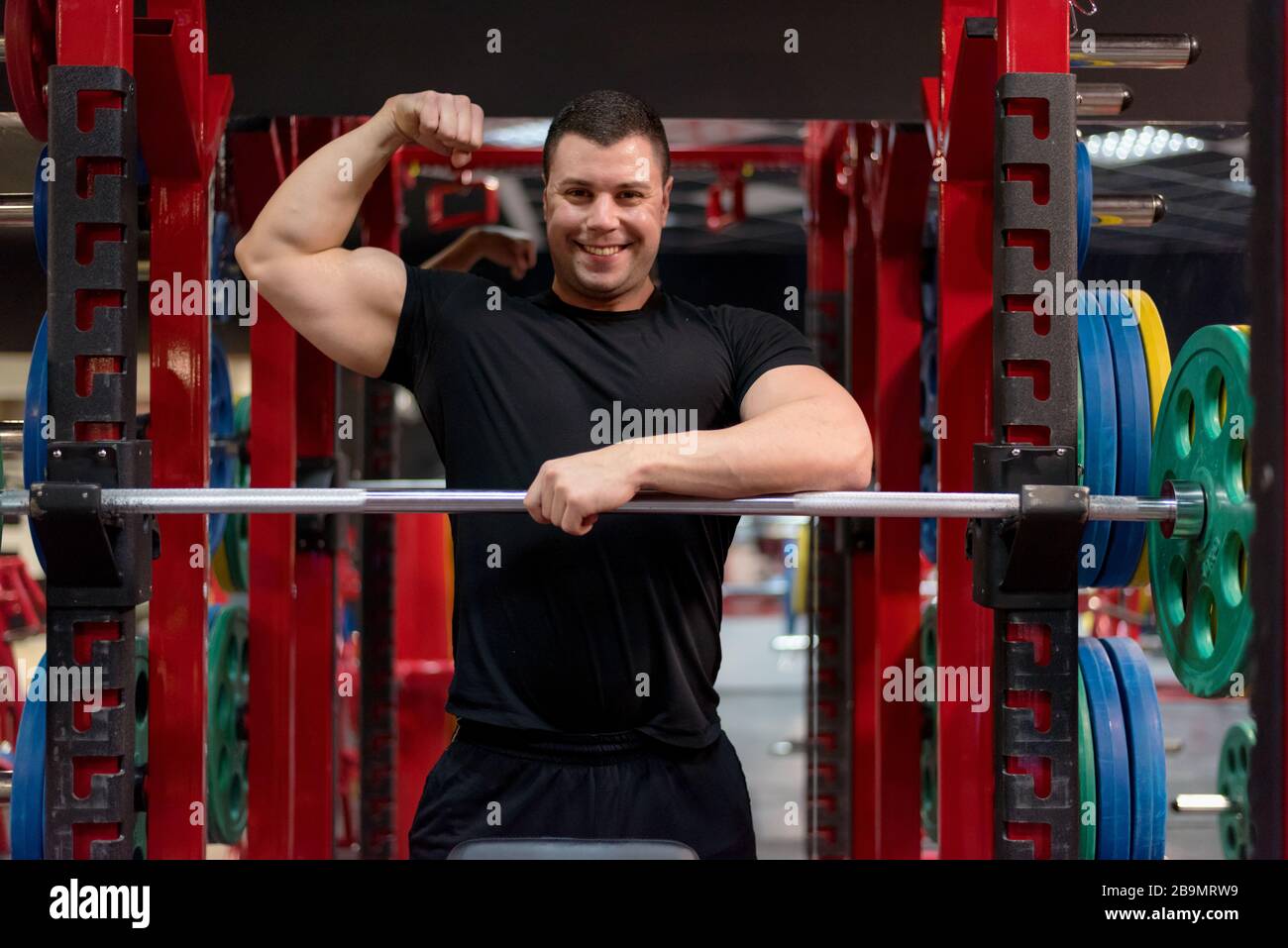 Fitness model Man posing in the gym. Handsome man with big muscles ...