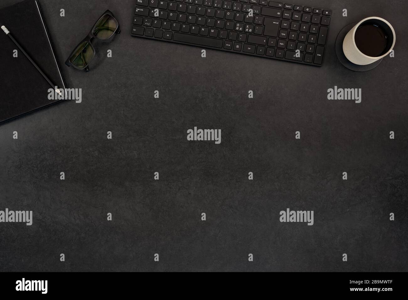 Top view of black concrete office desk with computer and supplies Stock ...