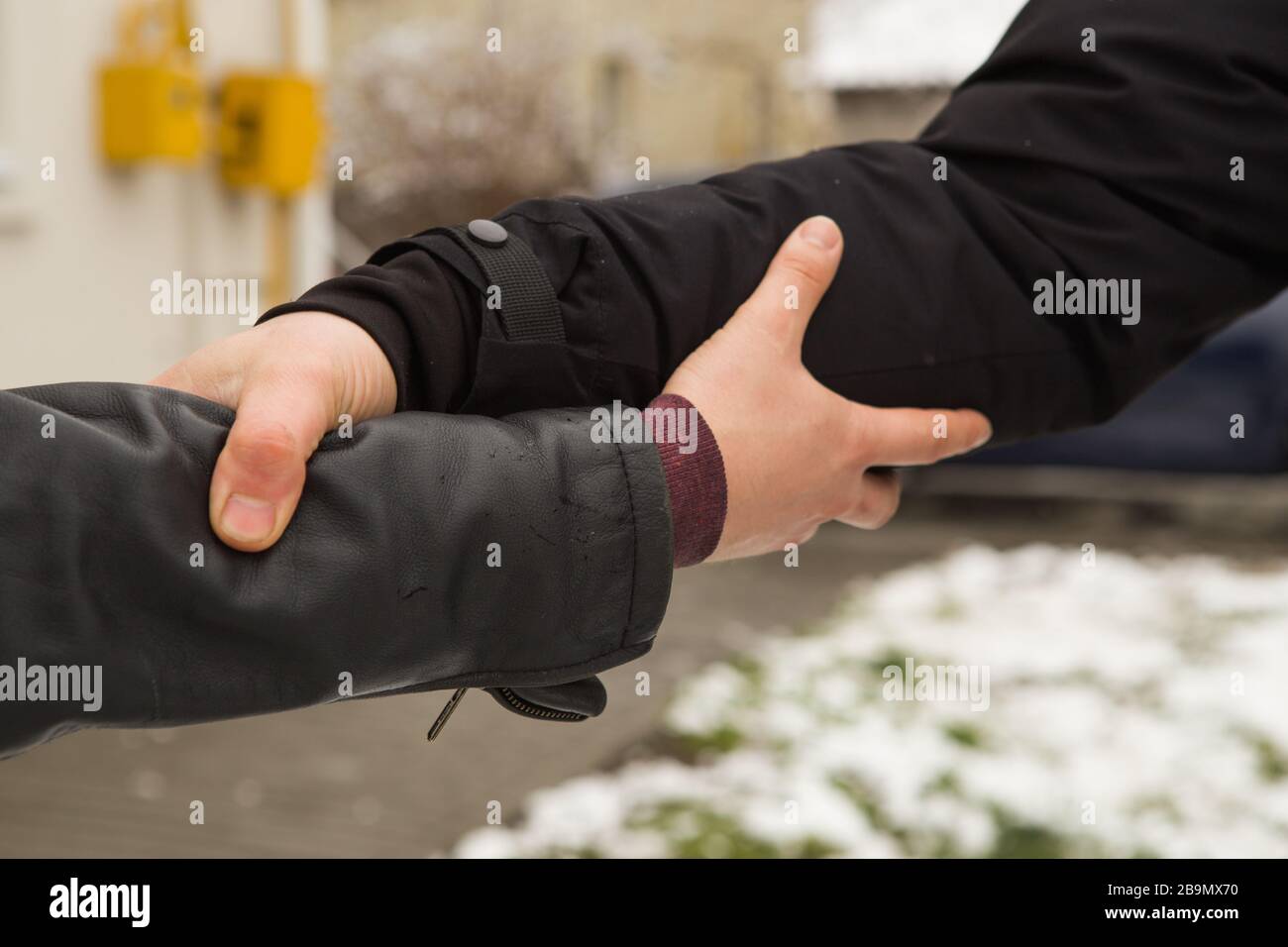Friends shaking elbows outdoors. People greeting together by new style ...