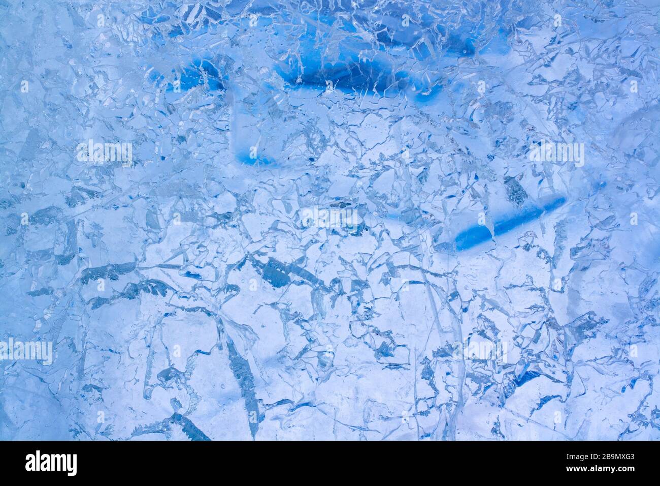 Texture of transparent clear ice with cracks and scratches. Blue Ice ...