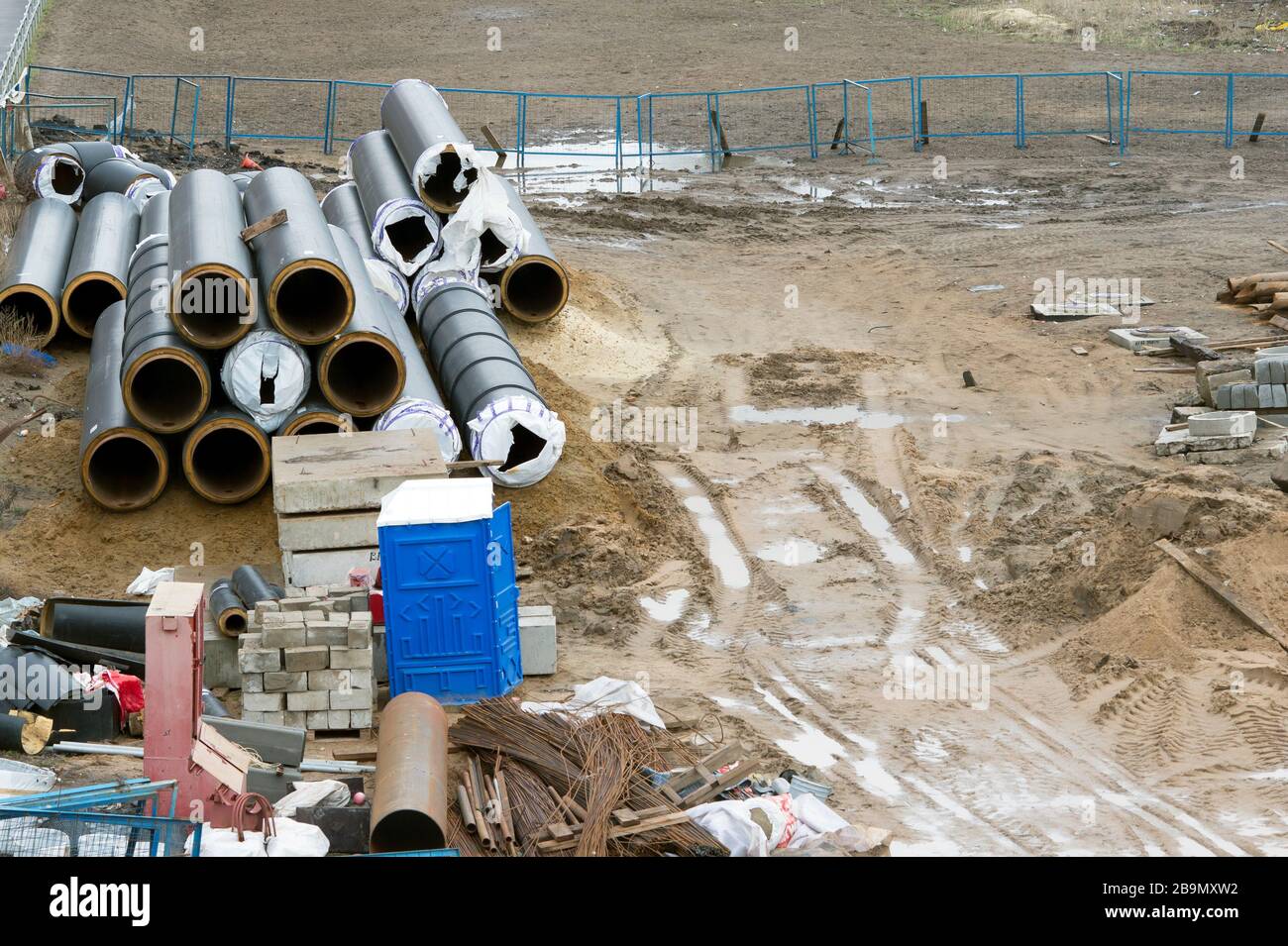Construction site with a lot of pipes , fittings, concrete blocks ...