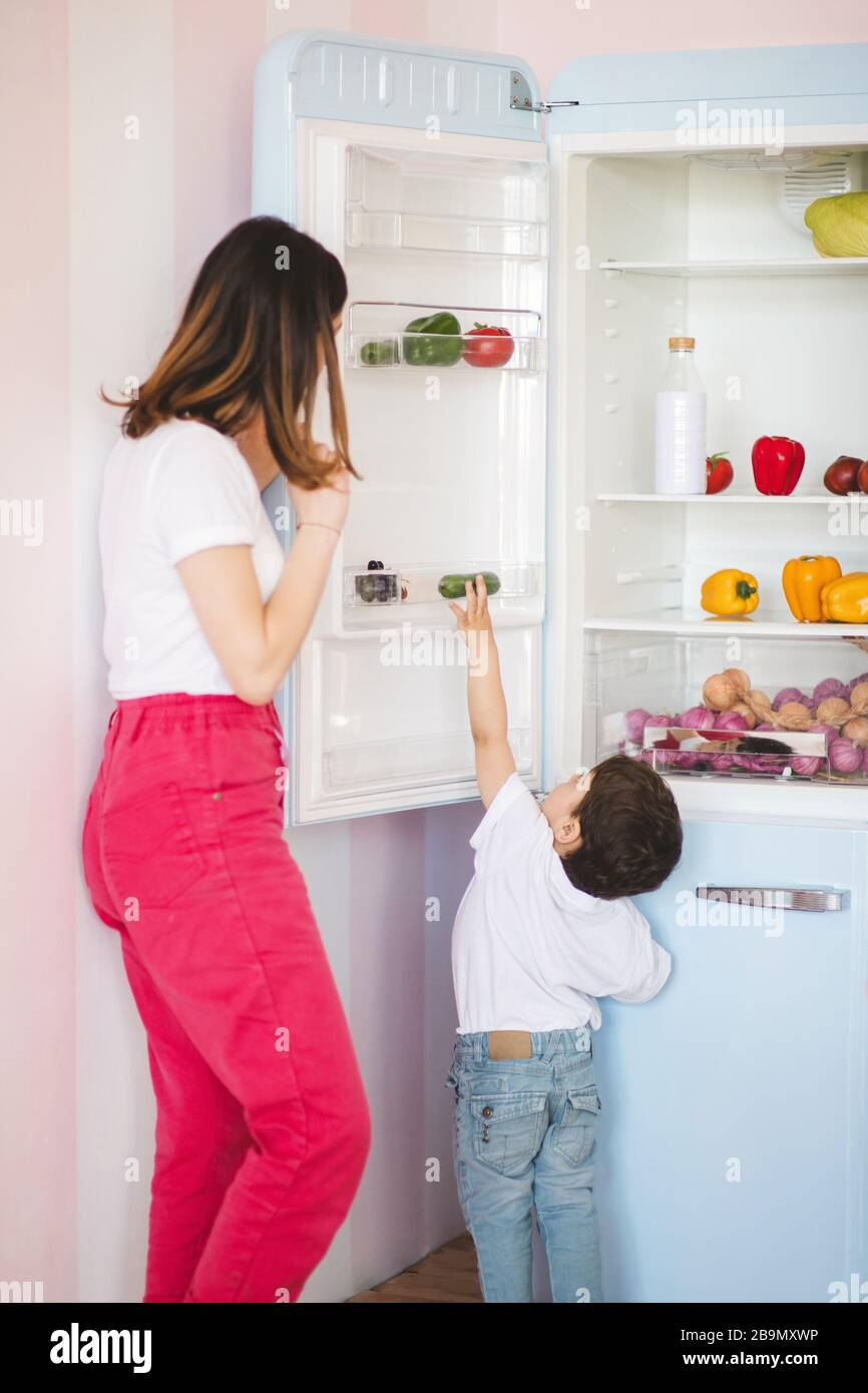 Woman opening fridge door hi-res stock photography and images - Alamy