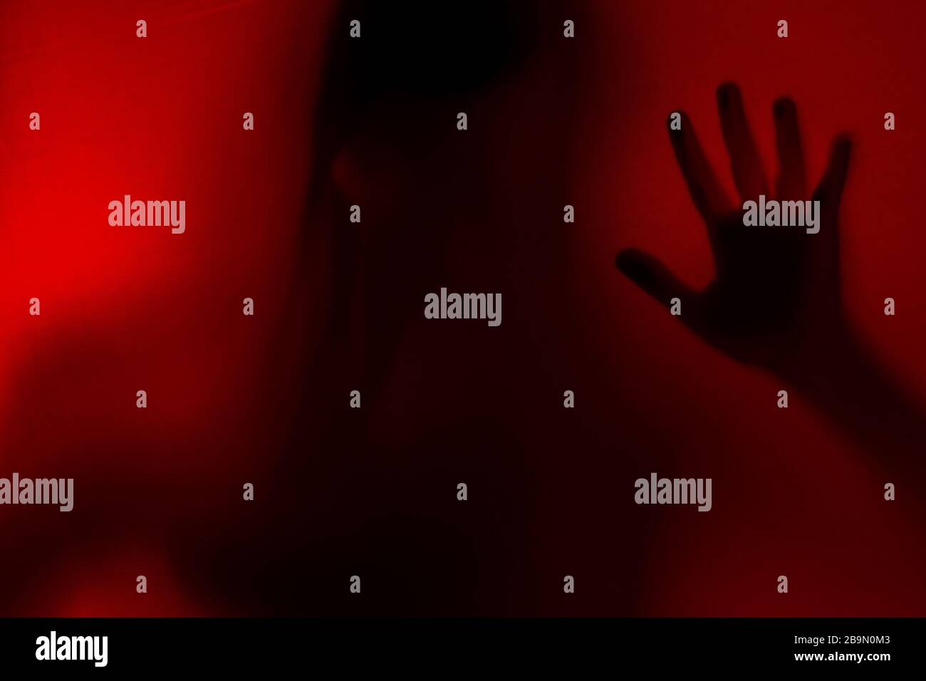 Blurred Woman's hand shadow asking for help. Horror and domestic ...