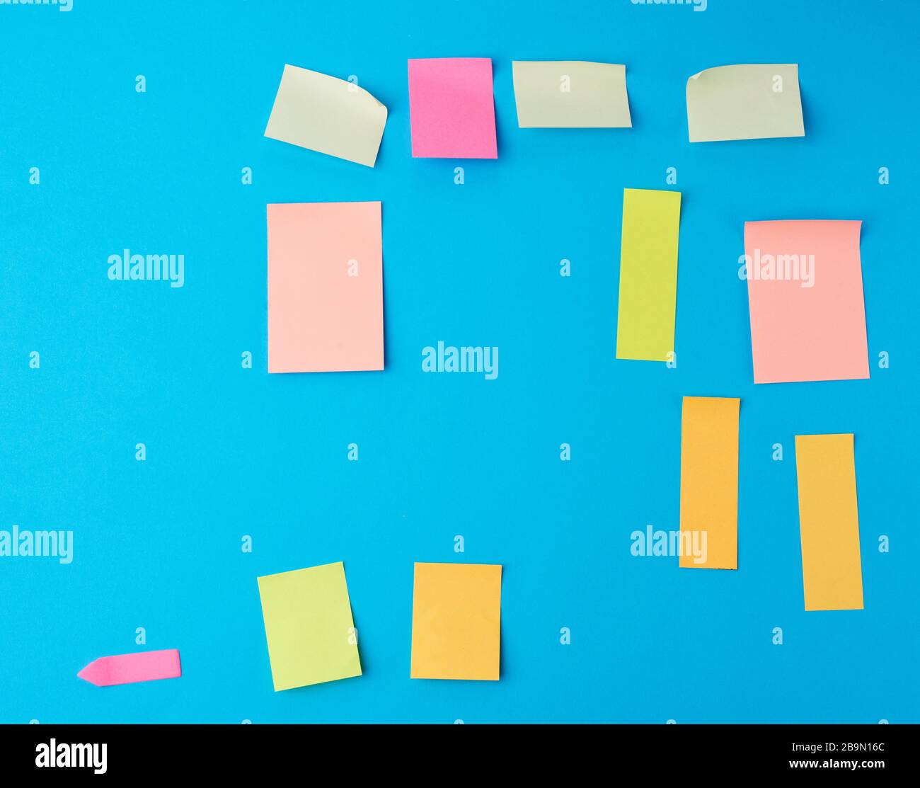 multicolored paper stickers of different shapes on a blue background ...