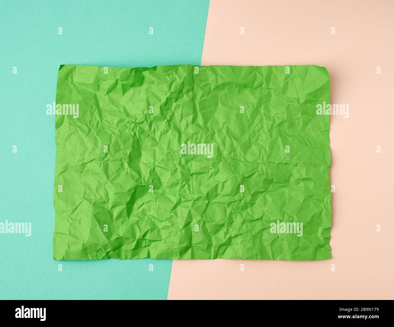 empty crumpled green rectangular sheet of paper a4 on a color ...