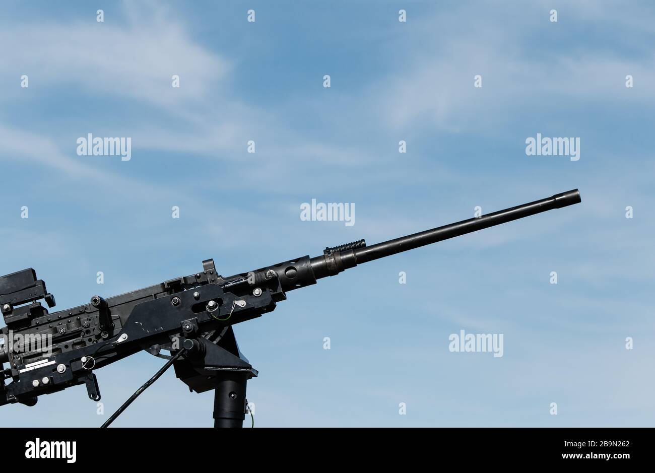 Close up view of the turret, armaments and gun with blue sky and clouds ...