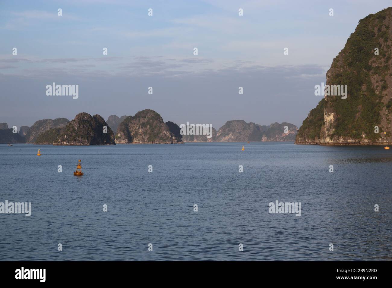LARGE TOWERING LIMESTONE ISLANDS TOPPED BY RAIN FOREST IN HALONG BAY ...