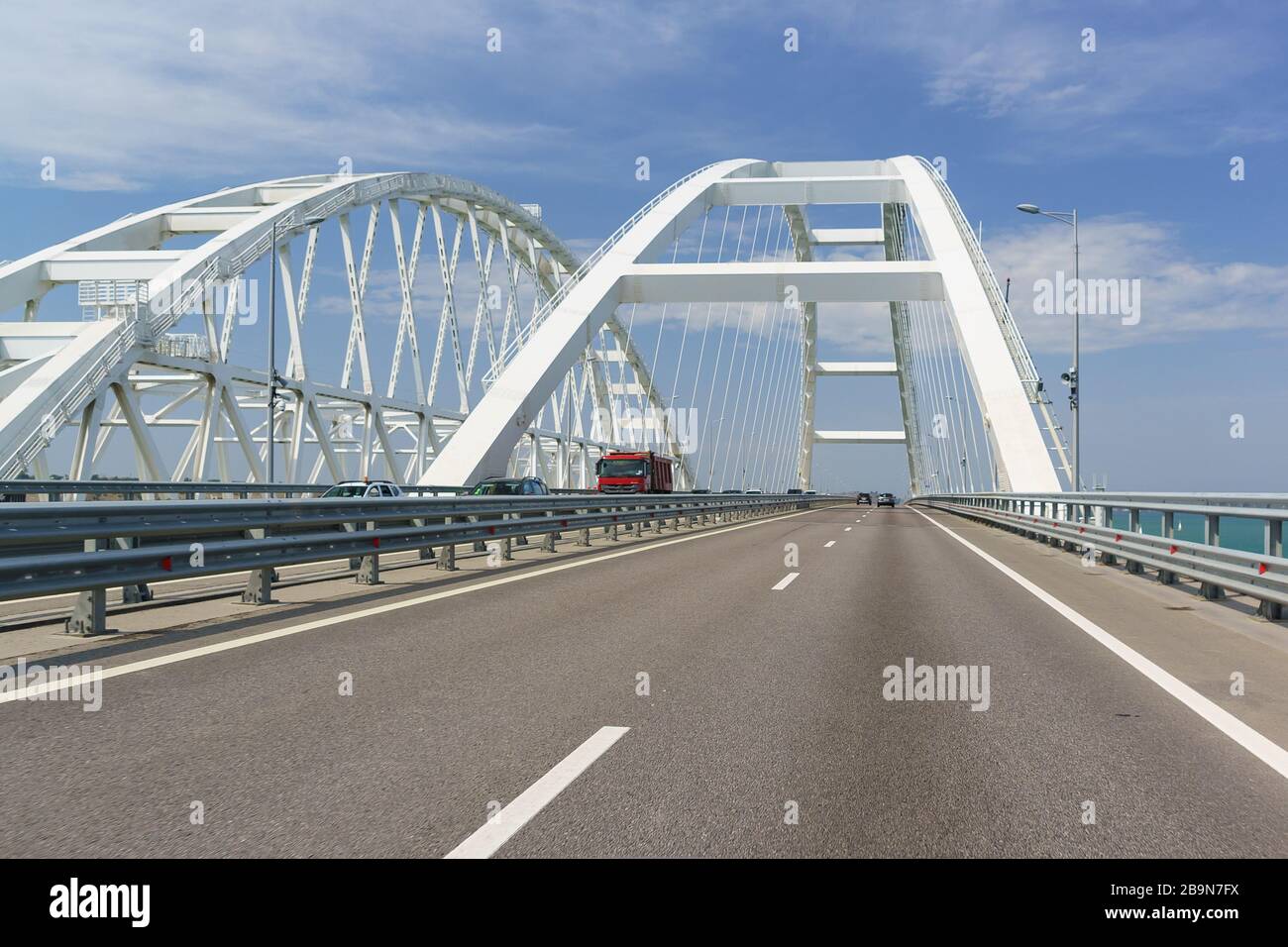 Crimean bridge across the Kerch Strait. Cars pass through the white ...