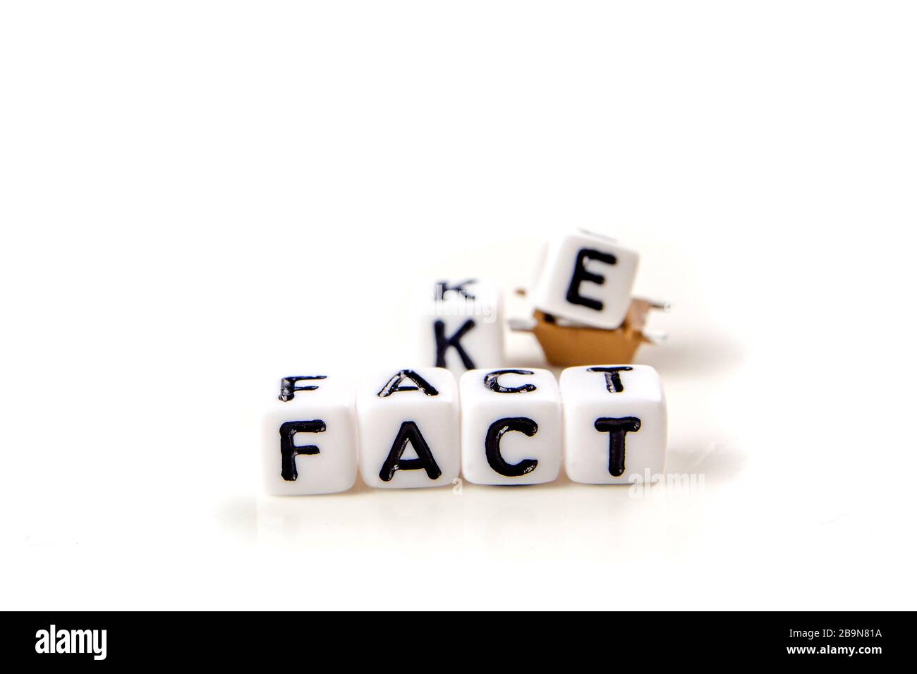 fake and fact text formed of white dices with black letters on white ...
