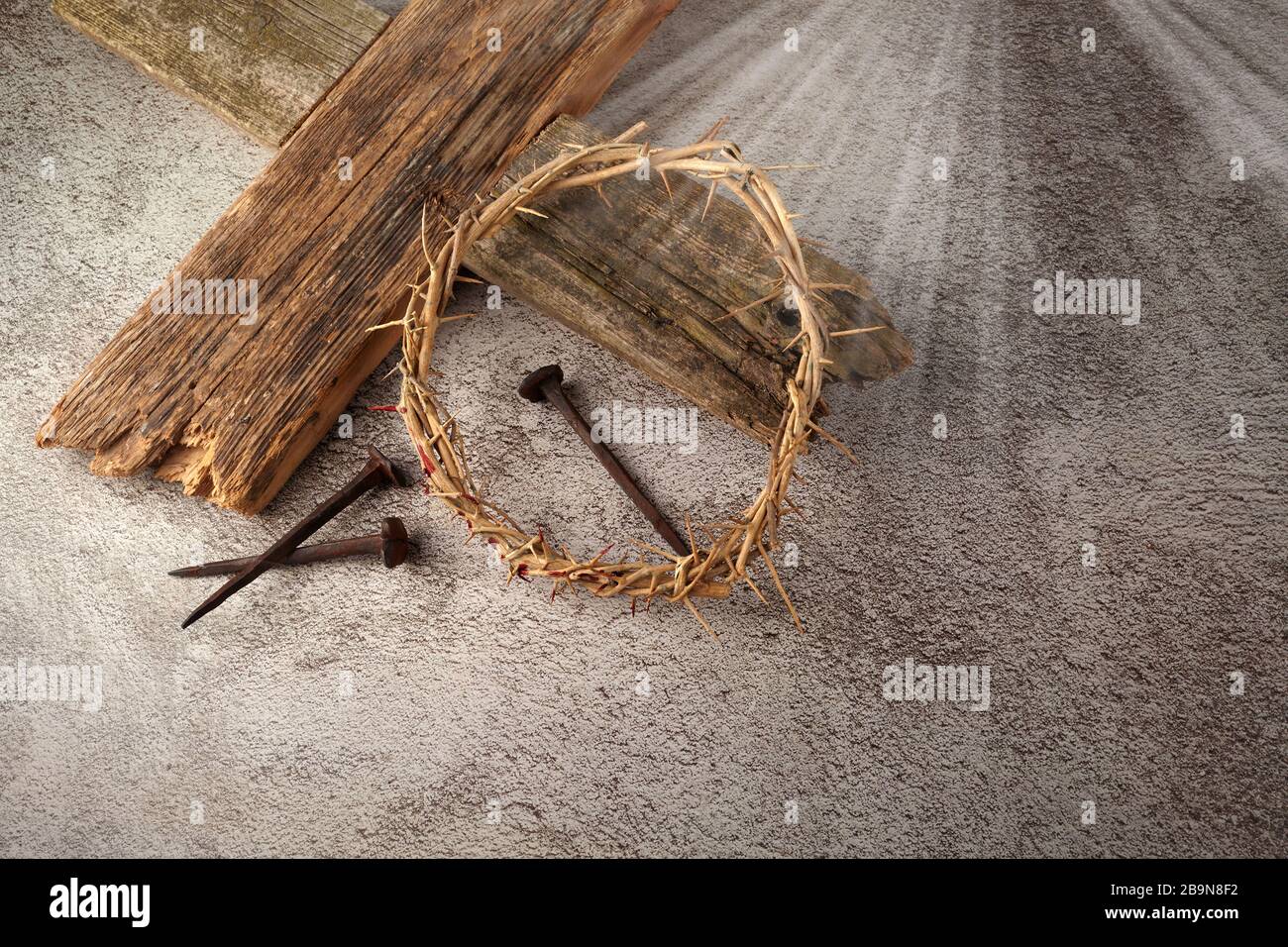 Easter background depicting the crucifixion with a rustic wooden cross, crown of thorns and ...