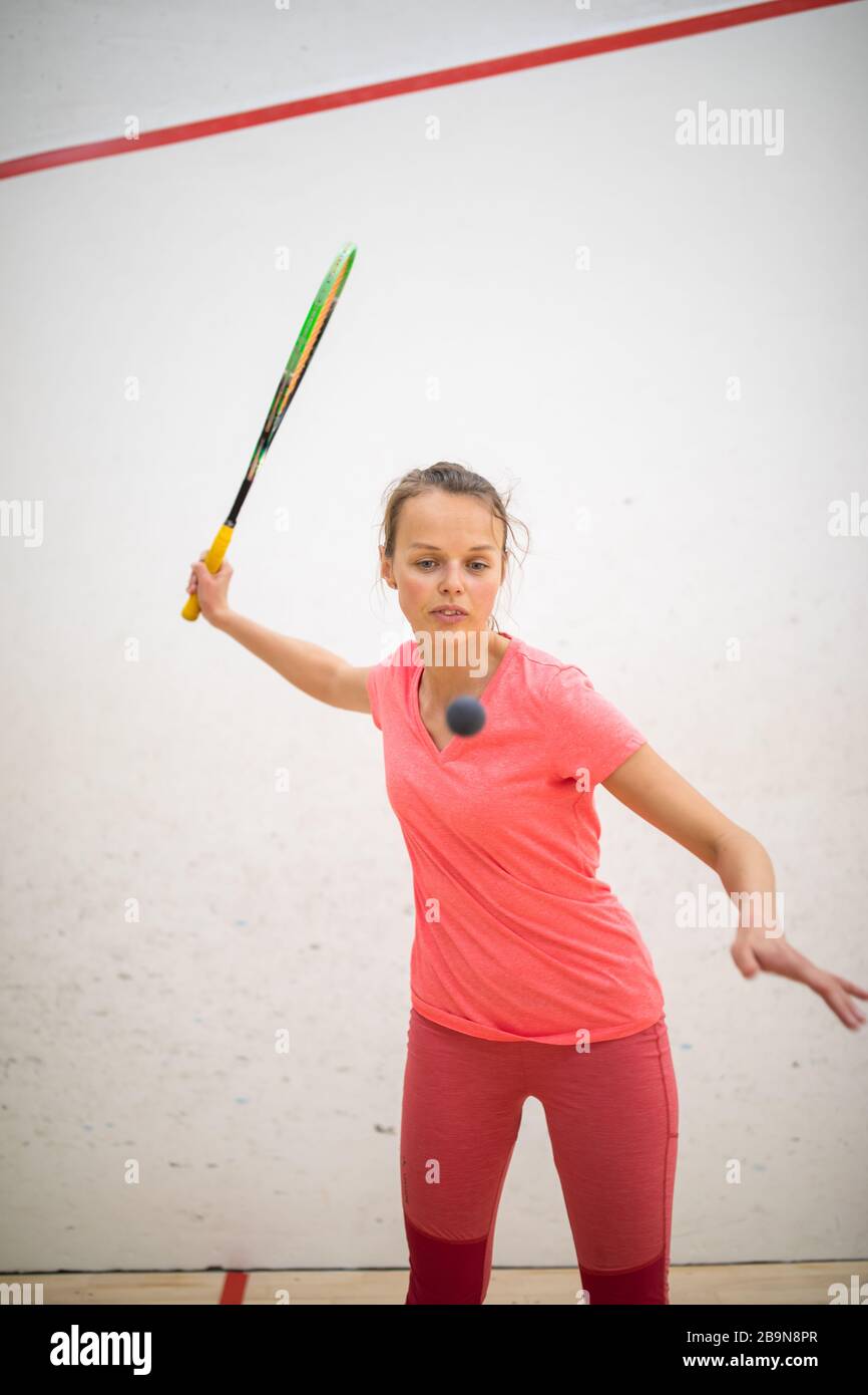 Squash players in action on a squash court (motion blurred image; color ...