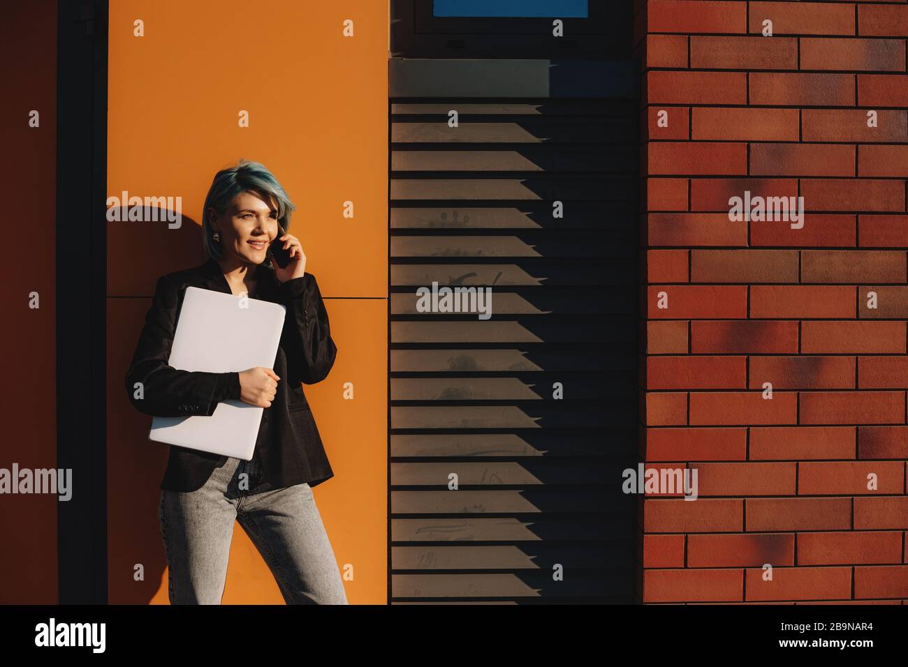 Stunning blue haired caucasian lady talking on phone while posing with ...