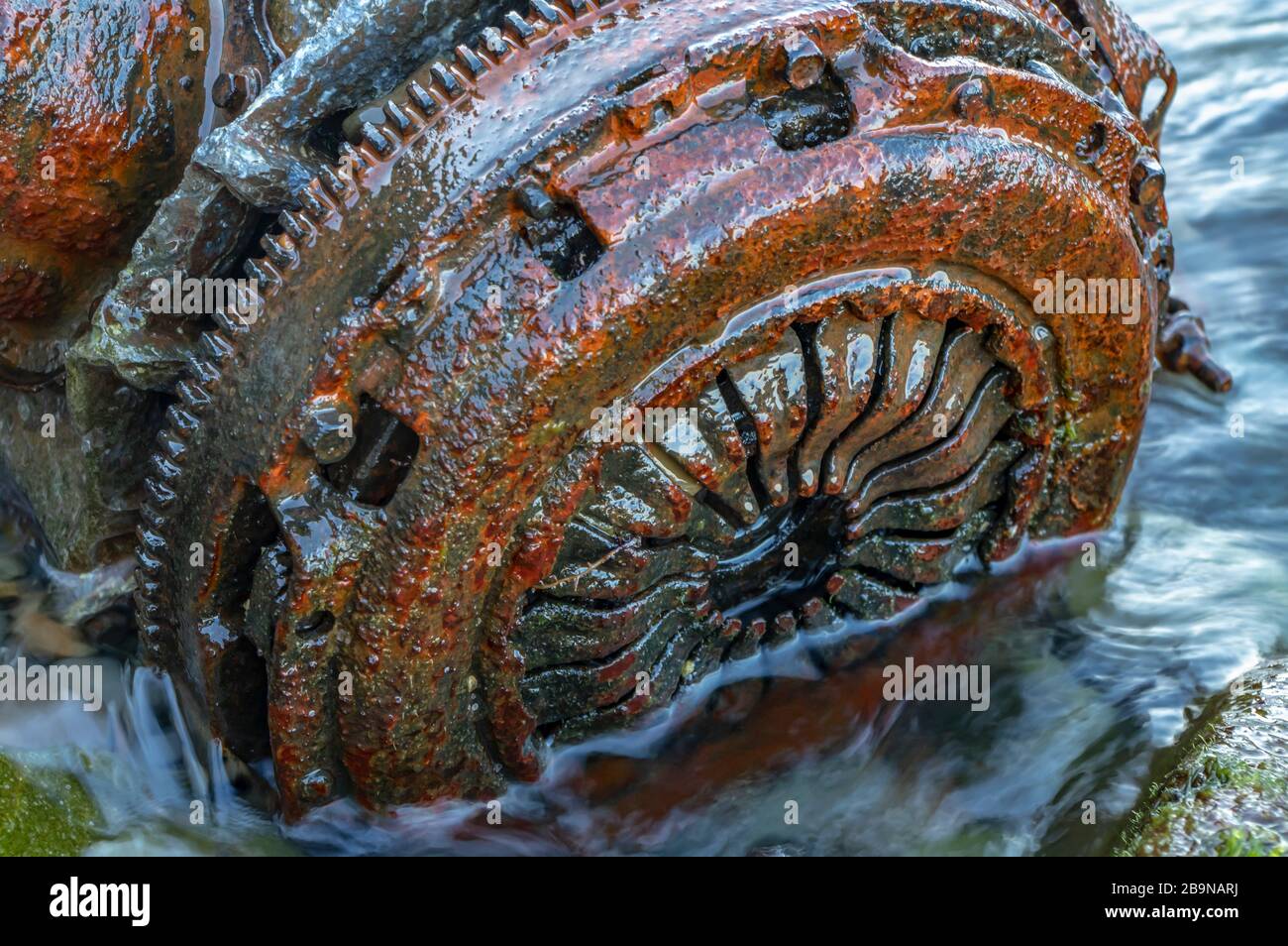 Old rusty engine lying among stones in the water Stock Photo - Alamy