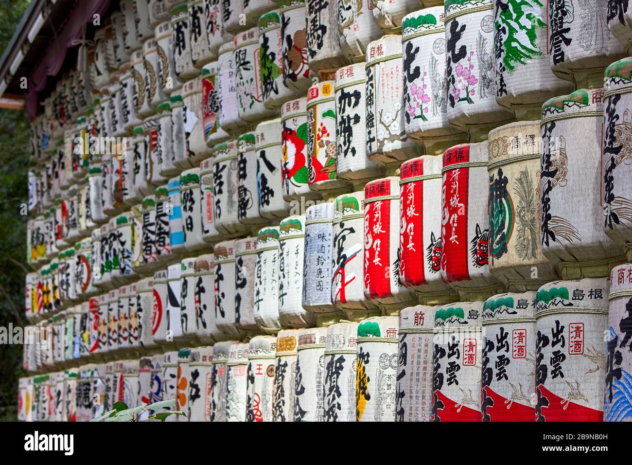 Many sake buckets standing on each other like a wall Stock Photo - Alamy