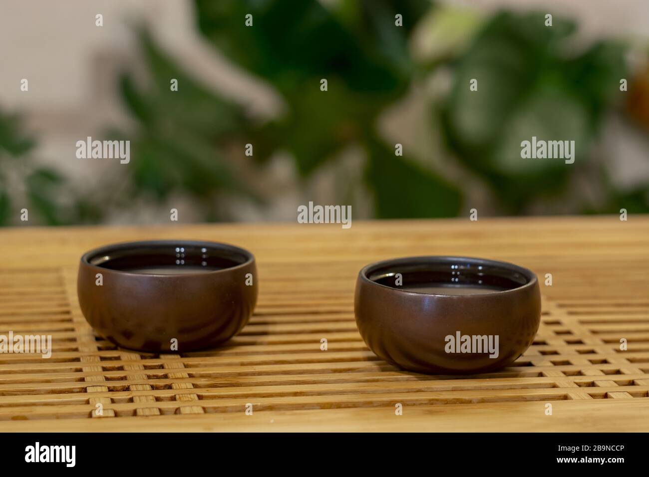 Two cups of tea on a Chinese table on a green background Stock Photo ...