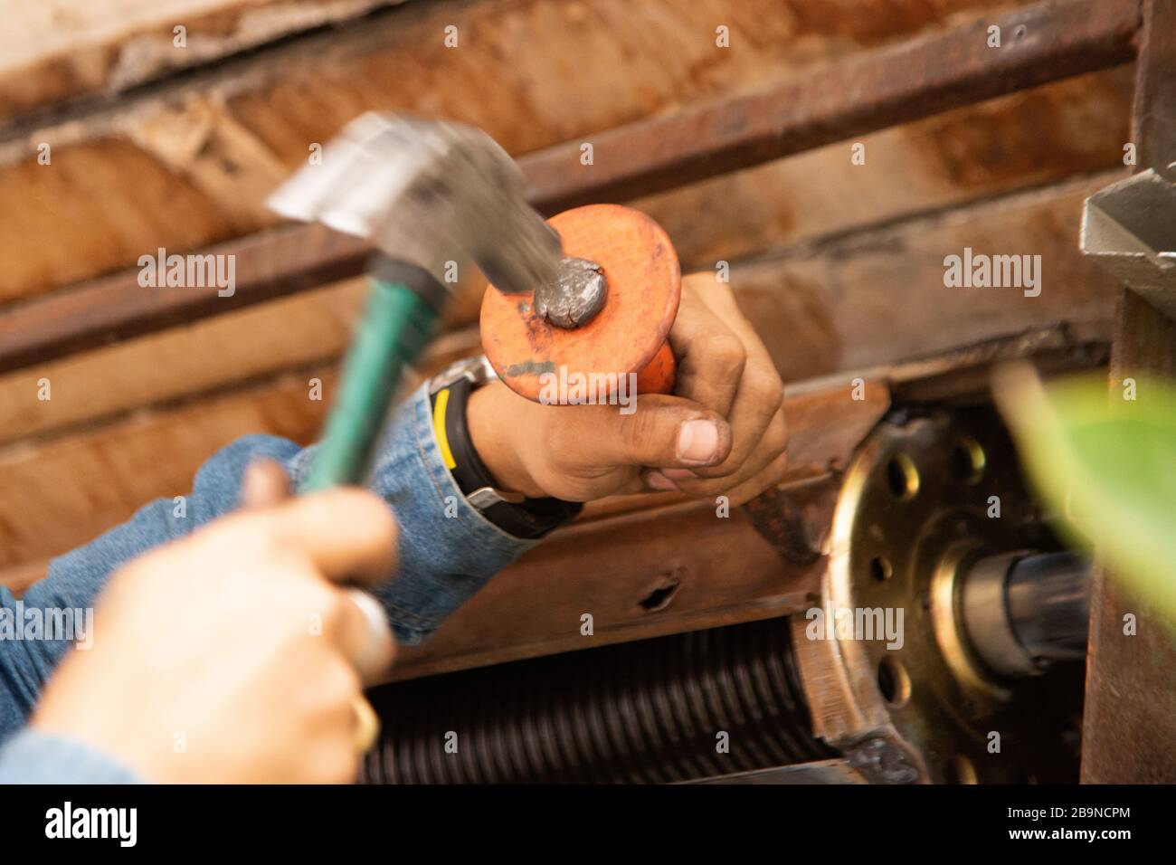 Human hand making holes using hole rolling gate puncher by hammer Stock ...
