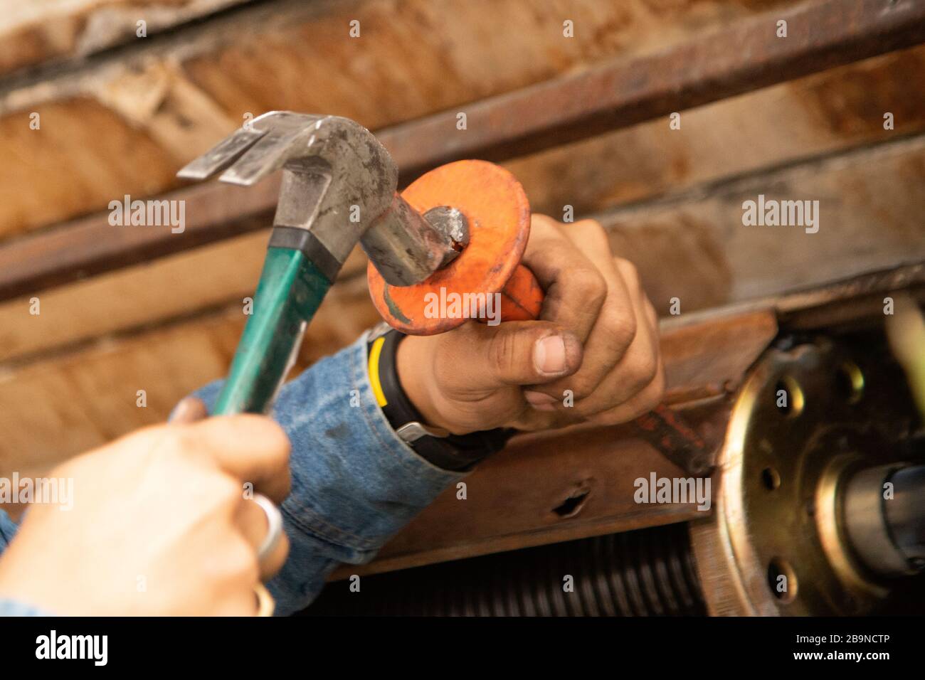 Human hand making holes using hole rolling gate puncher by hammer Stock ...