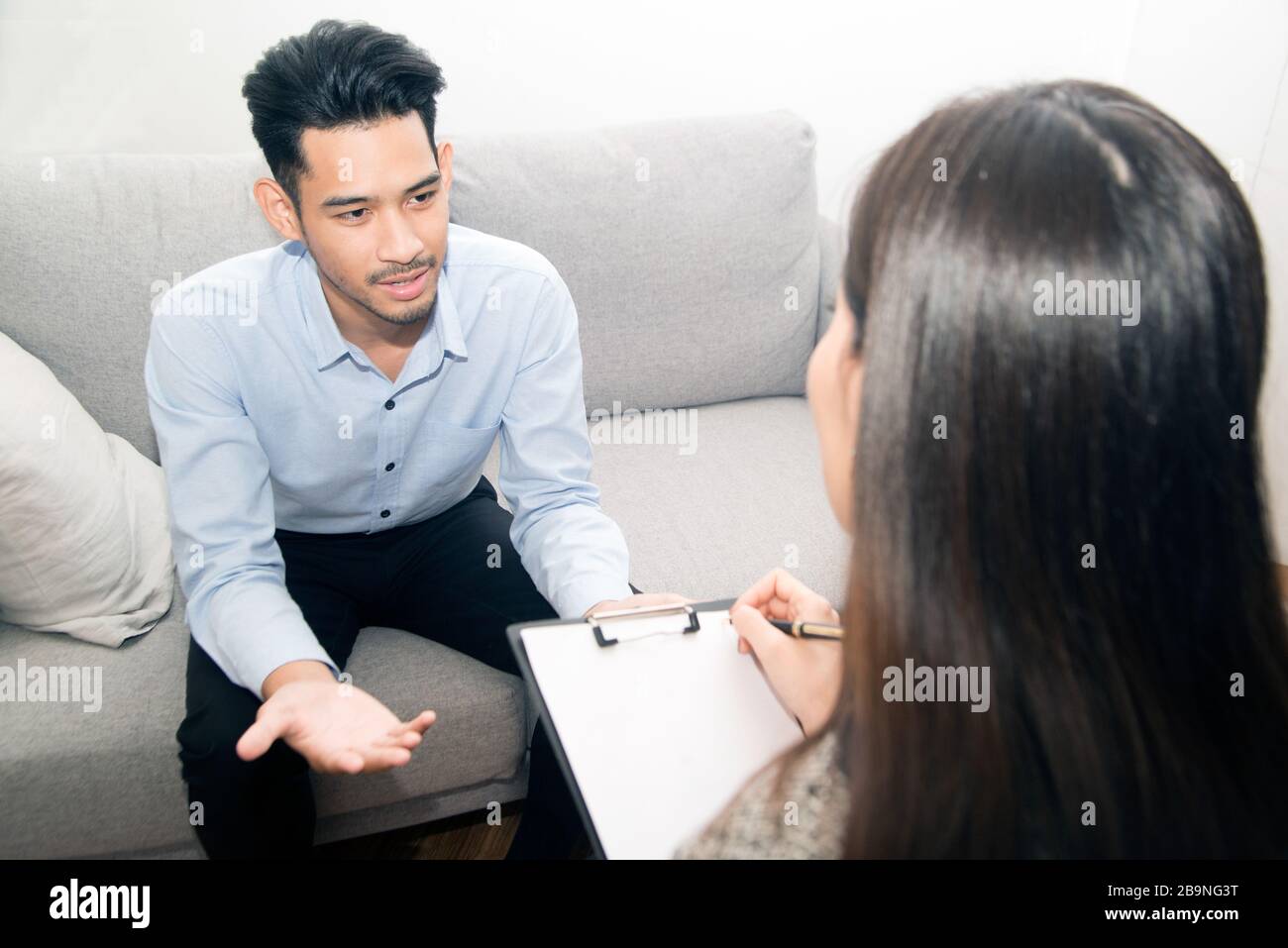 Psychological consultant concept is a young male patient sitting on ...