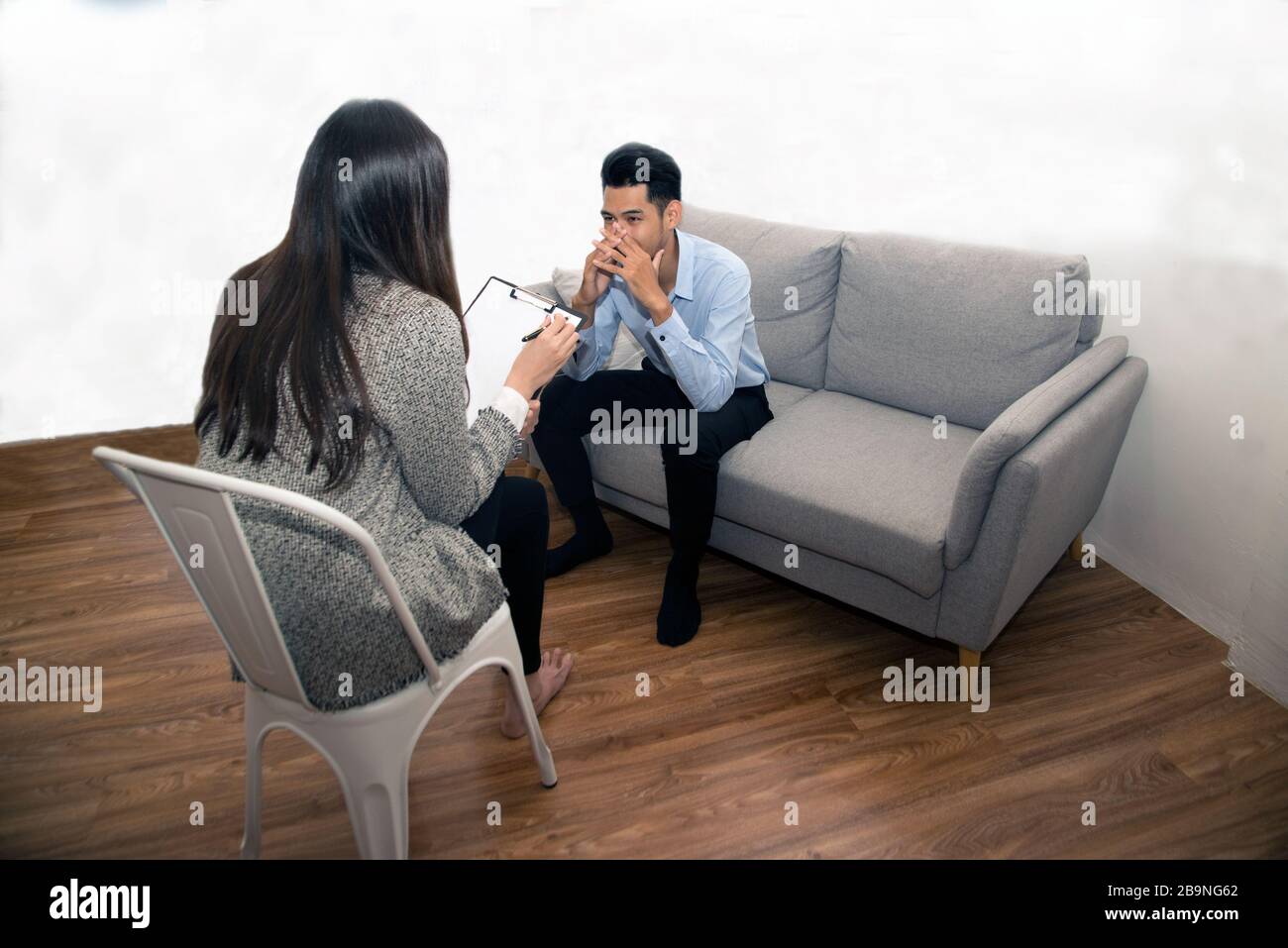 Psychological consultant concept is a young male patient sitting on ...