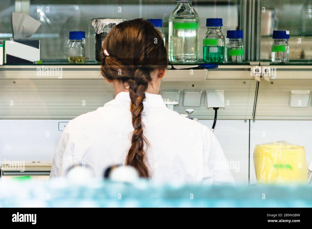 Close up of back of female scientist in laboratory Stock Photo - Alamy