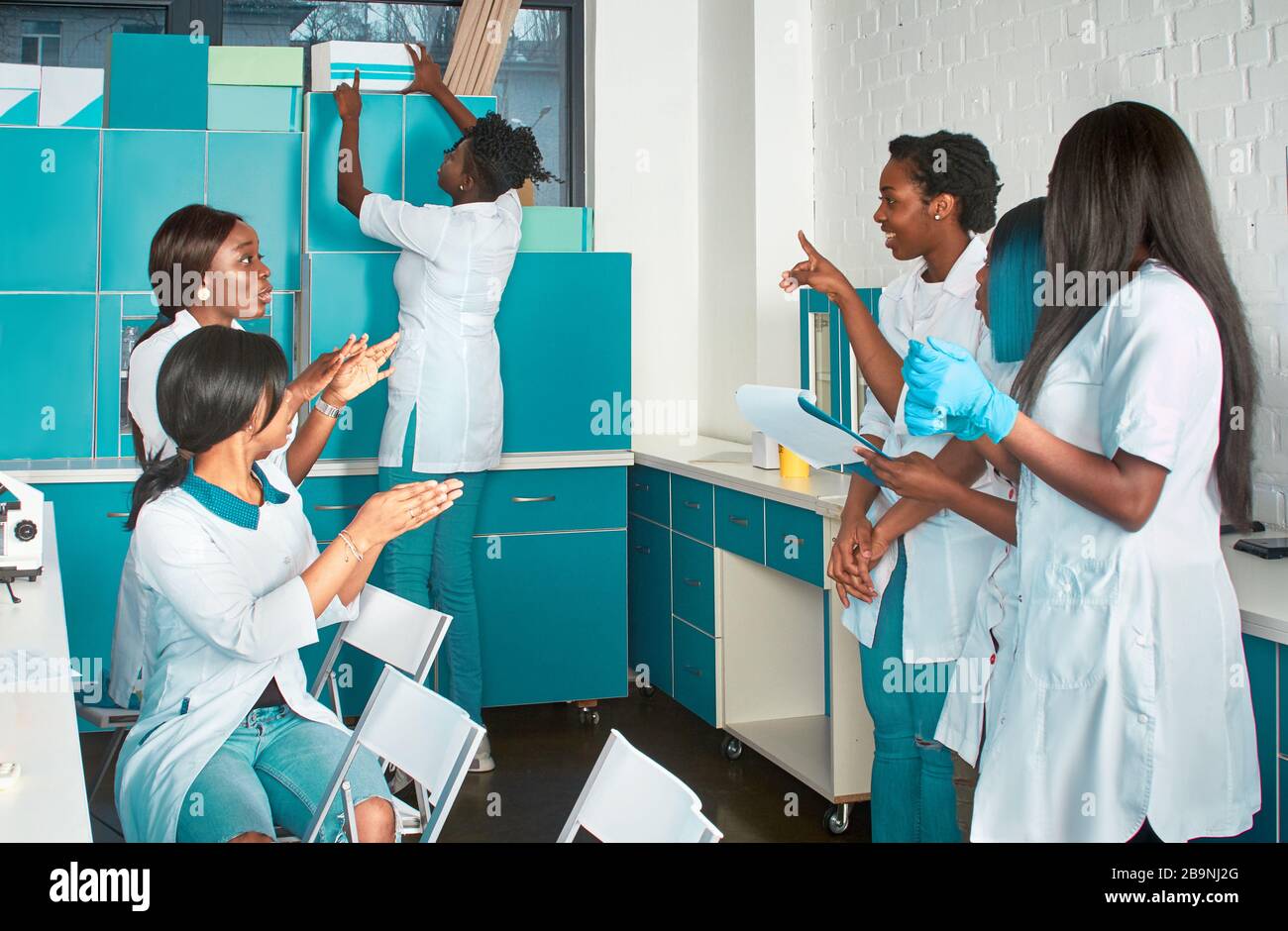 Female African medical students, young graduates or doctors discuss ...
