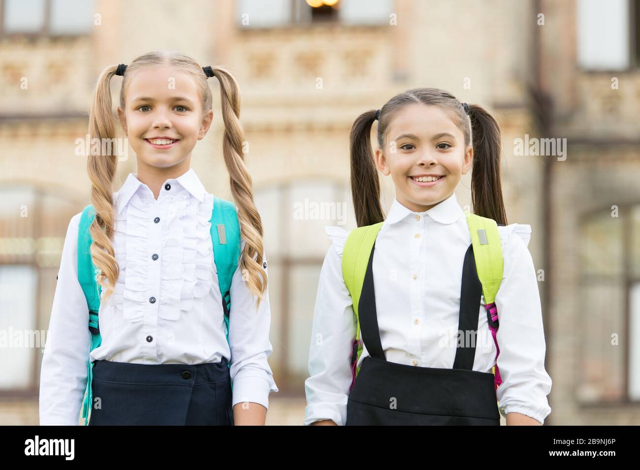 Cute schoolgirls with long ponytails looking charming. Ending of school ...