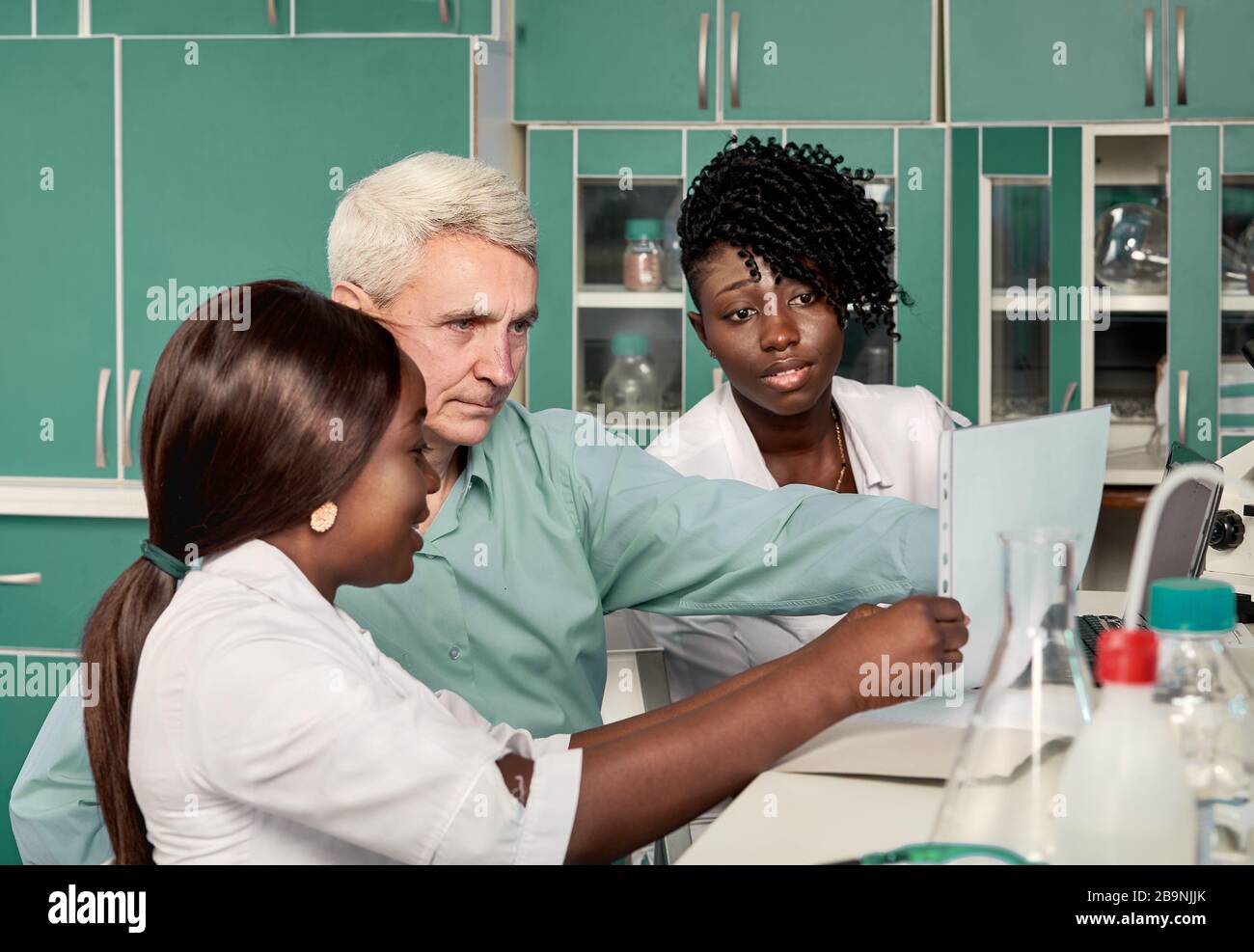 Female African medical students or young graduates discuss with ...