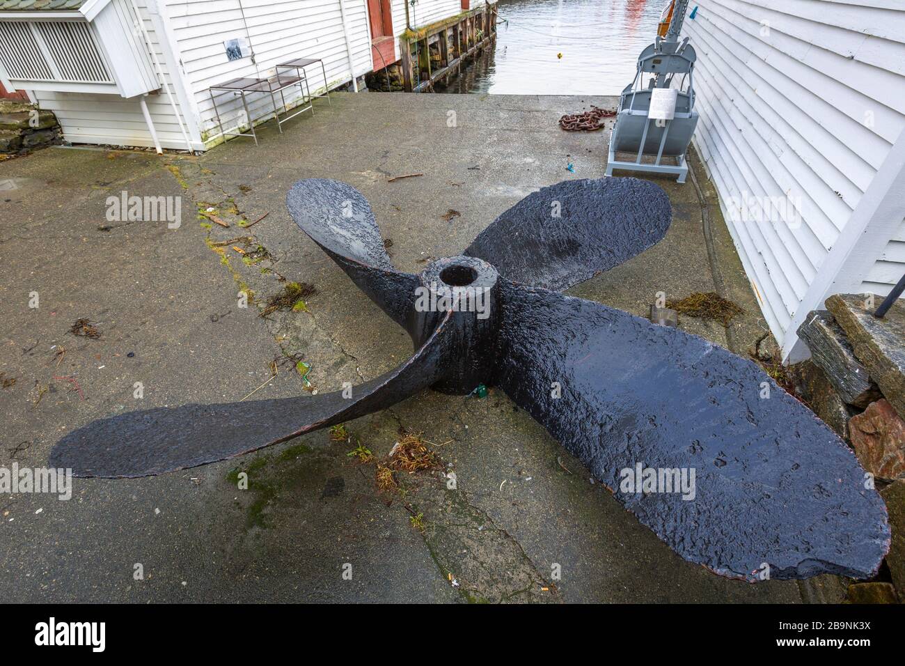 An old ship's propeller at the harbour of Alesund at the Norwegian Sea ...