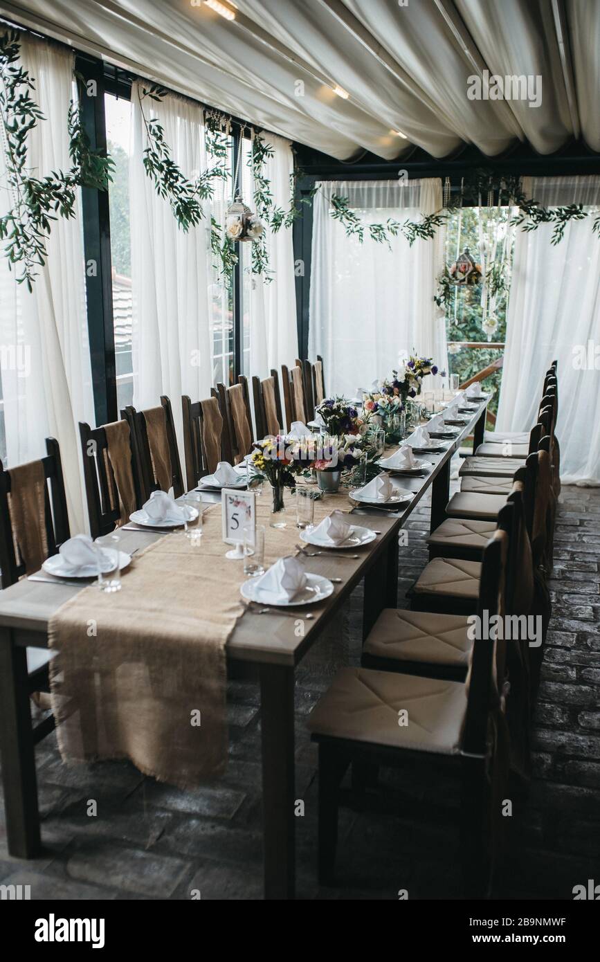 Decorated tables with candles and floral arrangements for celebration ...