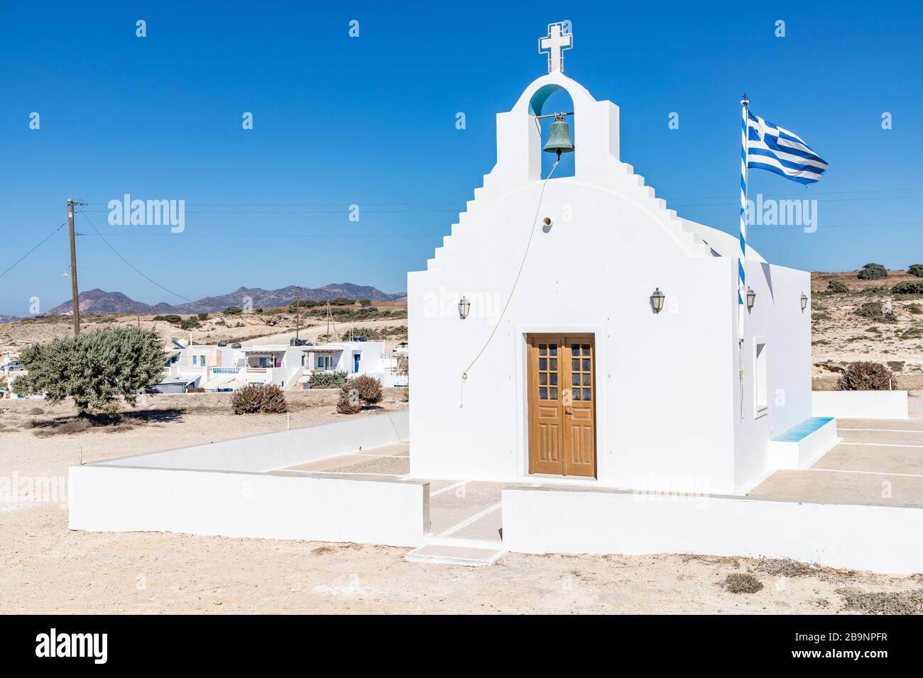 Agios Konstantinos church and Greek flag, Milos, Greece Stock Photo - Alamy