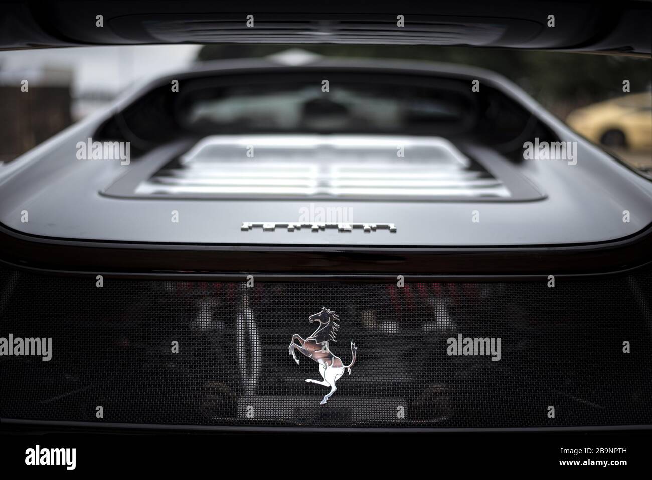 Close up of a Ferrari prancing horse badge on the rear of a black ...