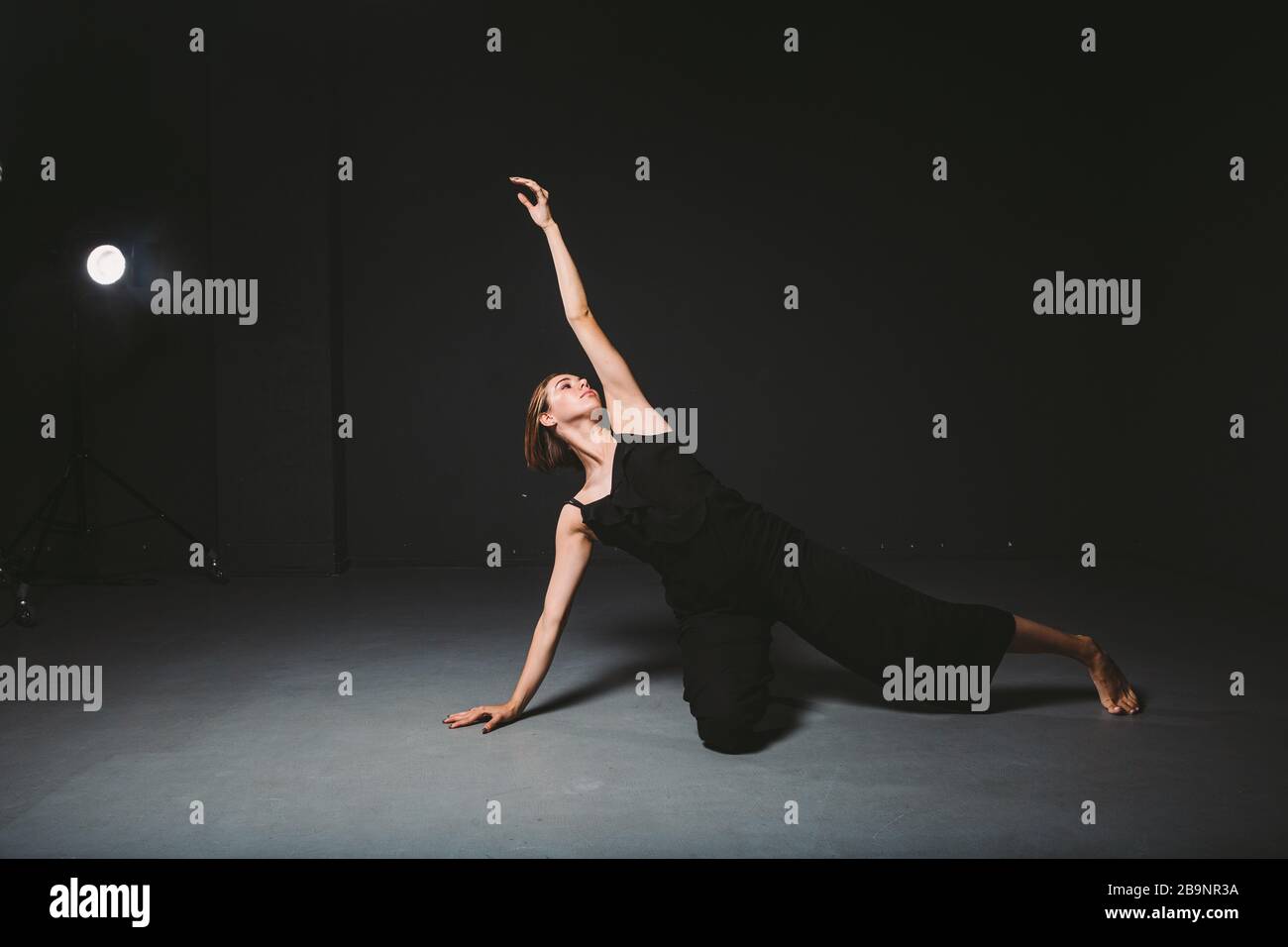 Portrait of a beautiful woman dancing on black background. Ballet and ...