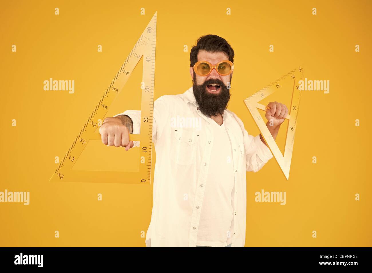 Making geometry fun. Funny hipster using geometrical tools at geometry ...
