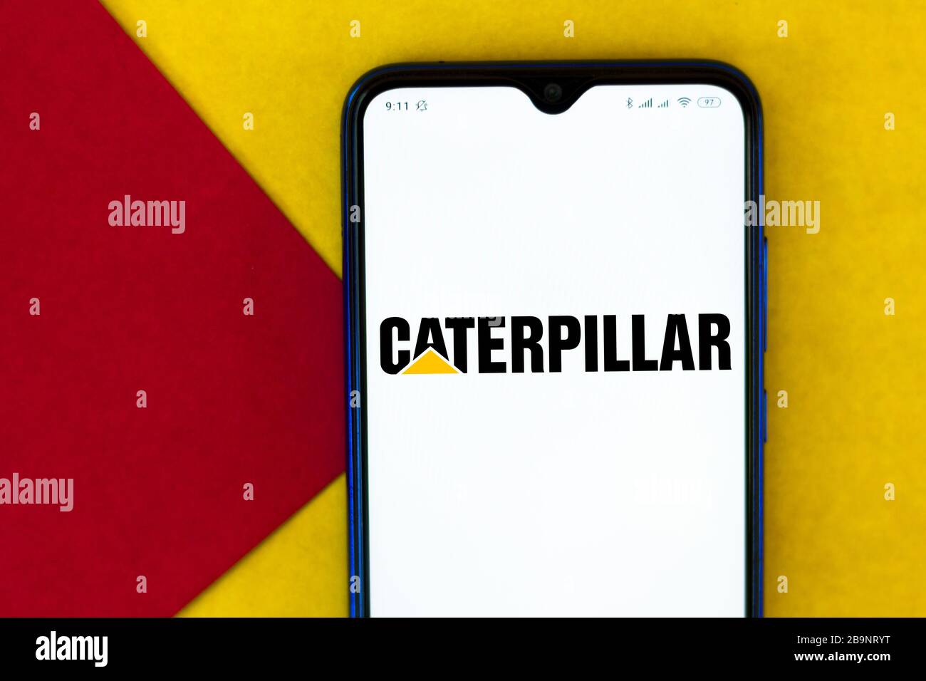 In this photo illustration a Caterpillar logo seen displayed on a ...