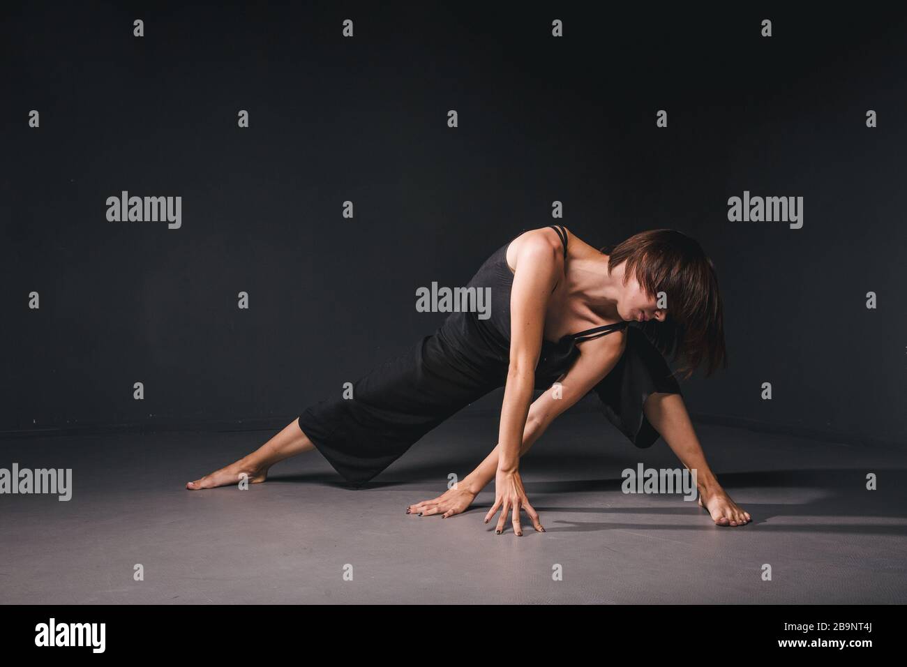 Portrait of a beautiful woman dancing on black background. Ballet and ...