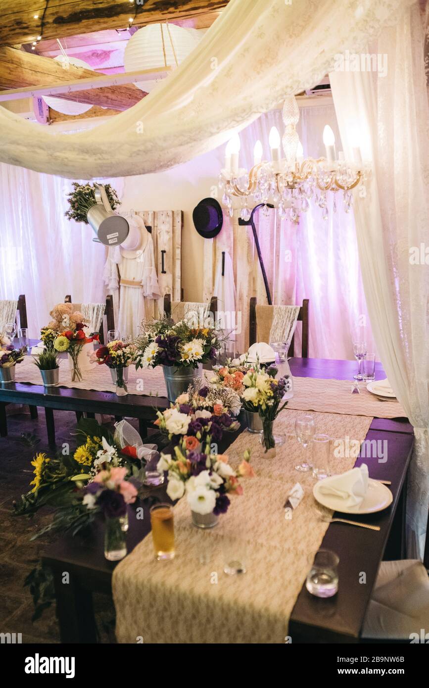 Decorated tables with candles and floral arrangements for celebration ...