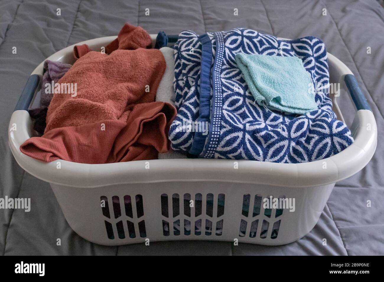 Freshly laundered clothes neatly in a laundry basket waiting to be ...