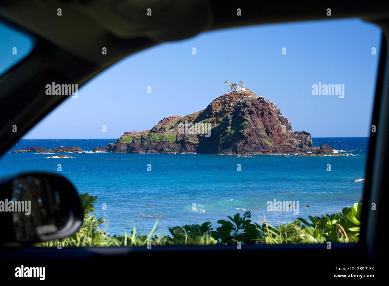 Alau Island off the coast of Hana seen through a car window at Koki ...
