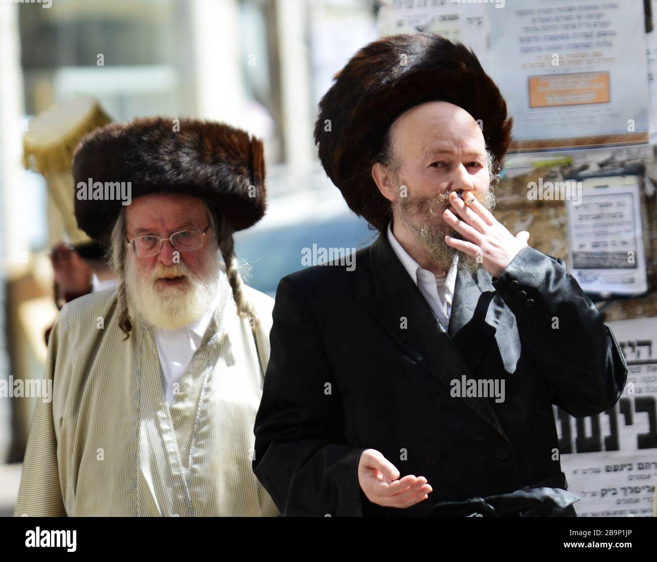 An Orthodox Jewish man smoking a cigarette Stock Photo - Alamy