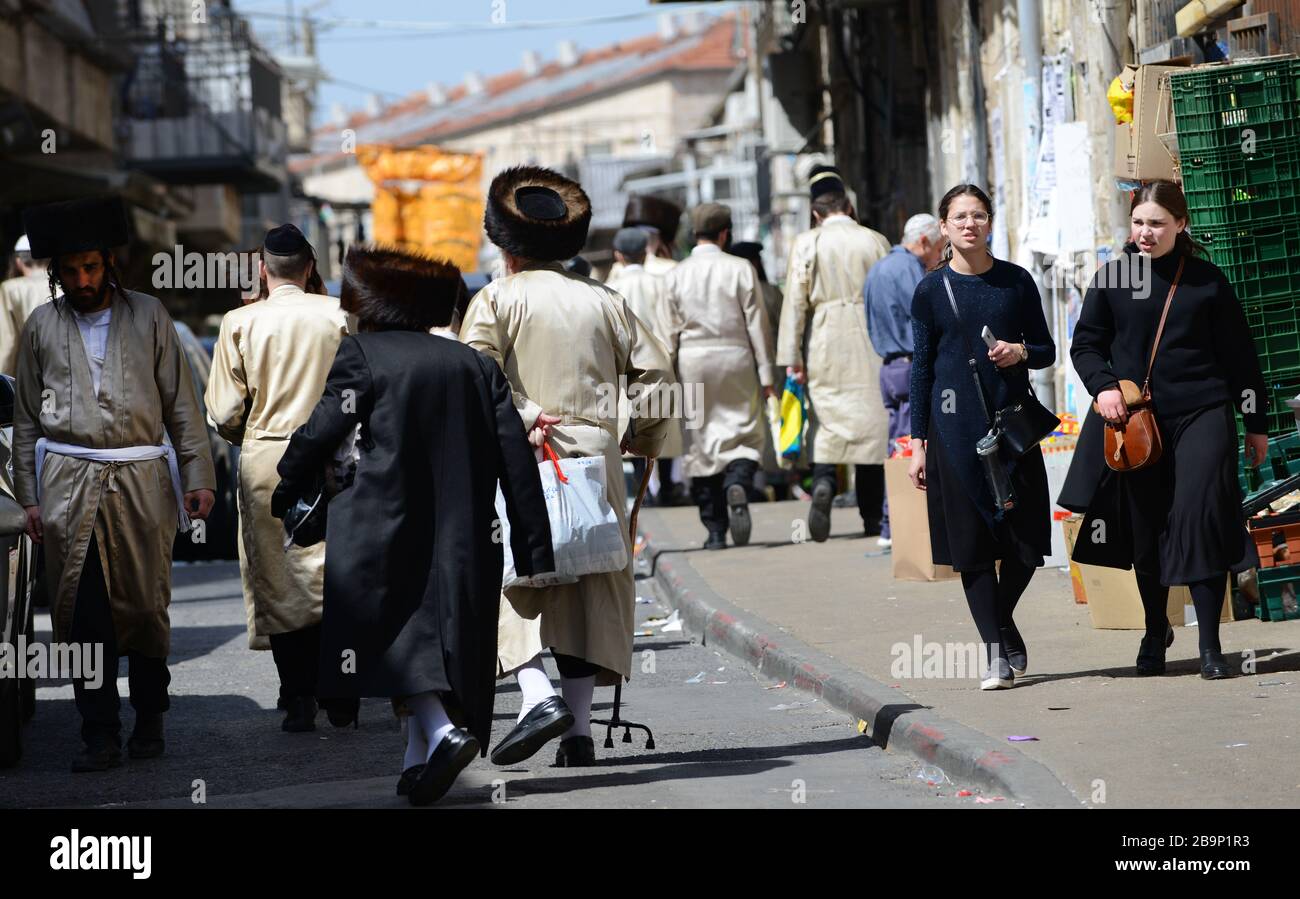 Jewish men wearing traditional shtreimel ( fur hat ) walking on Mea ...