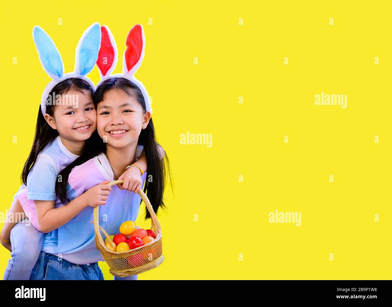 Happy Easter day. Kid with colorful eggs toy on yellow background ...