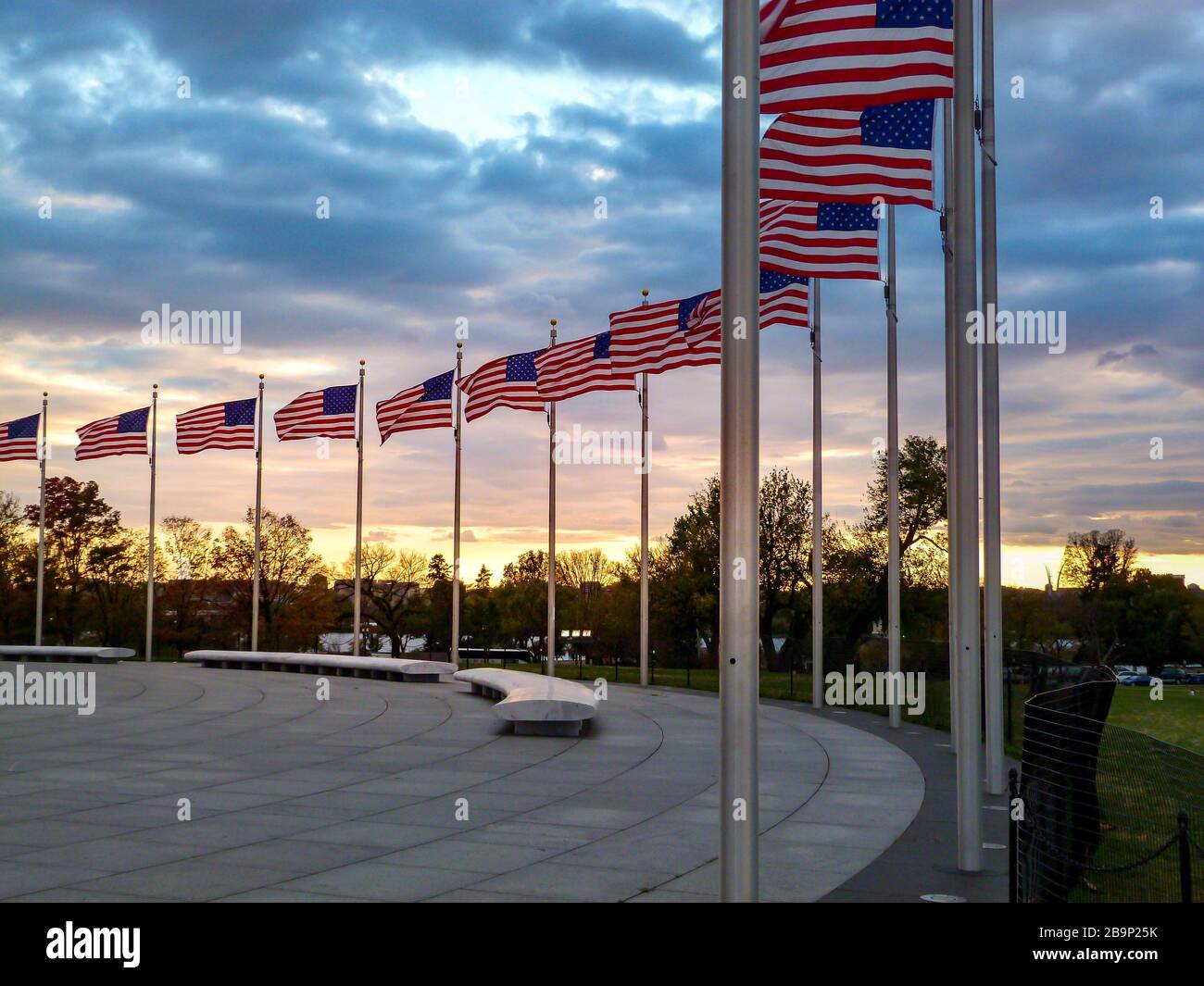 Many columns with American flags during the sunset Stock Photo - Alamy