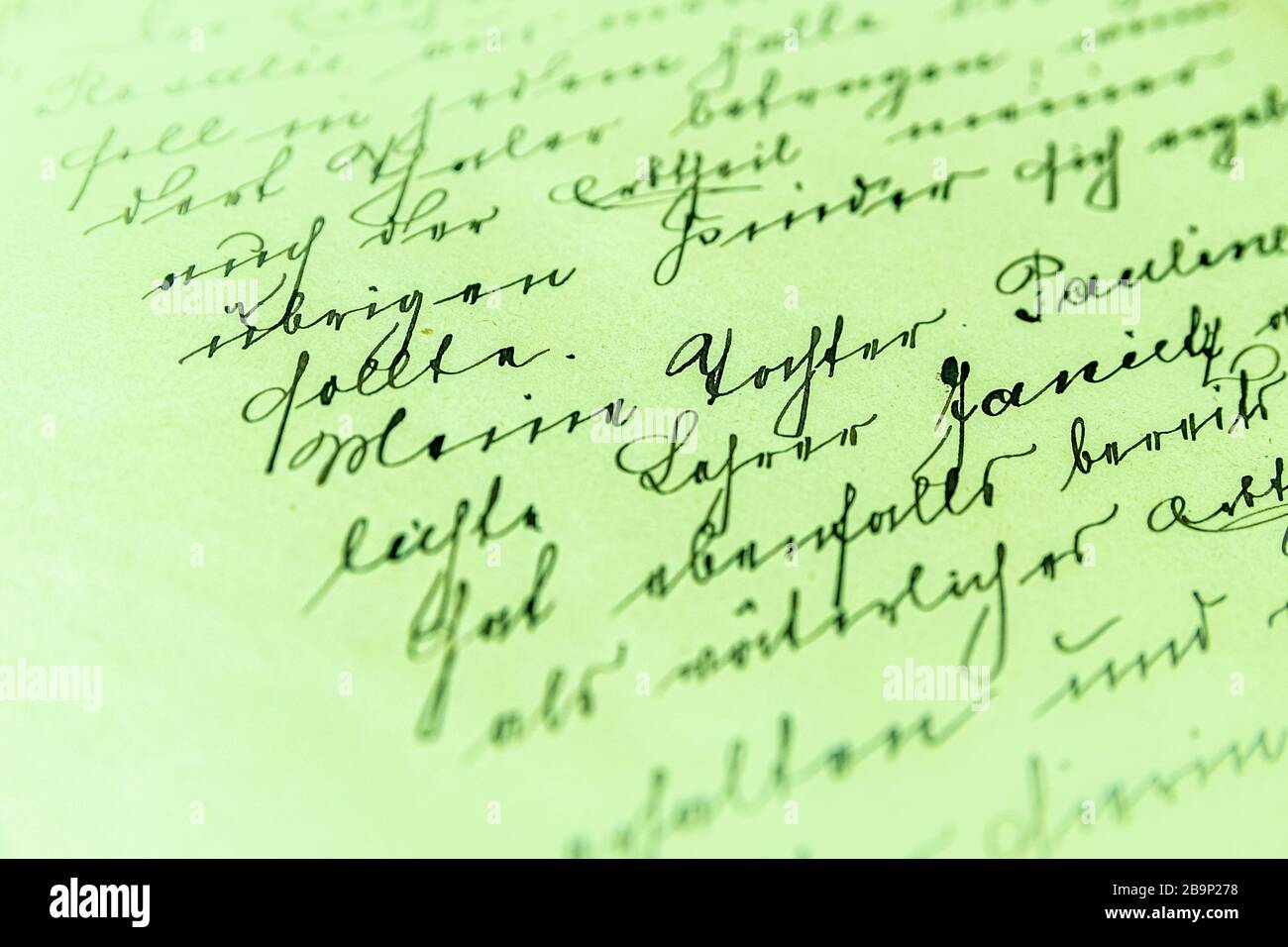 Closeup of a text written with fancy handwriting in a diary under the ...