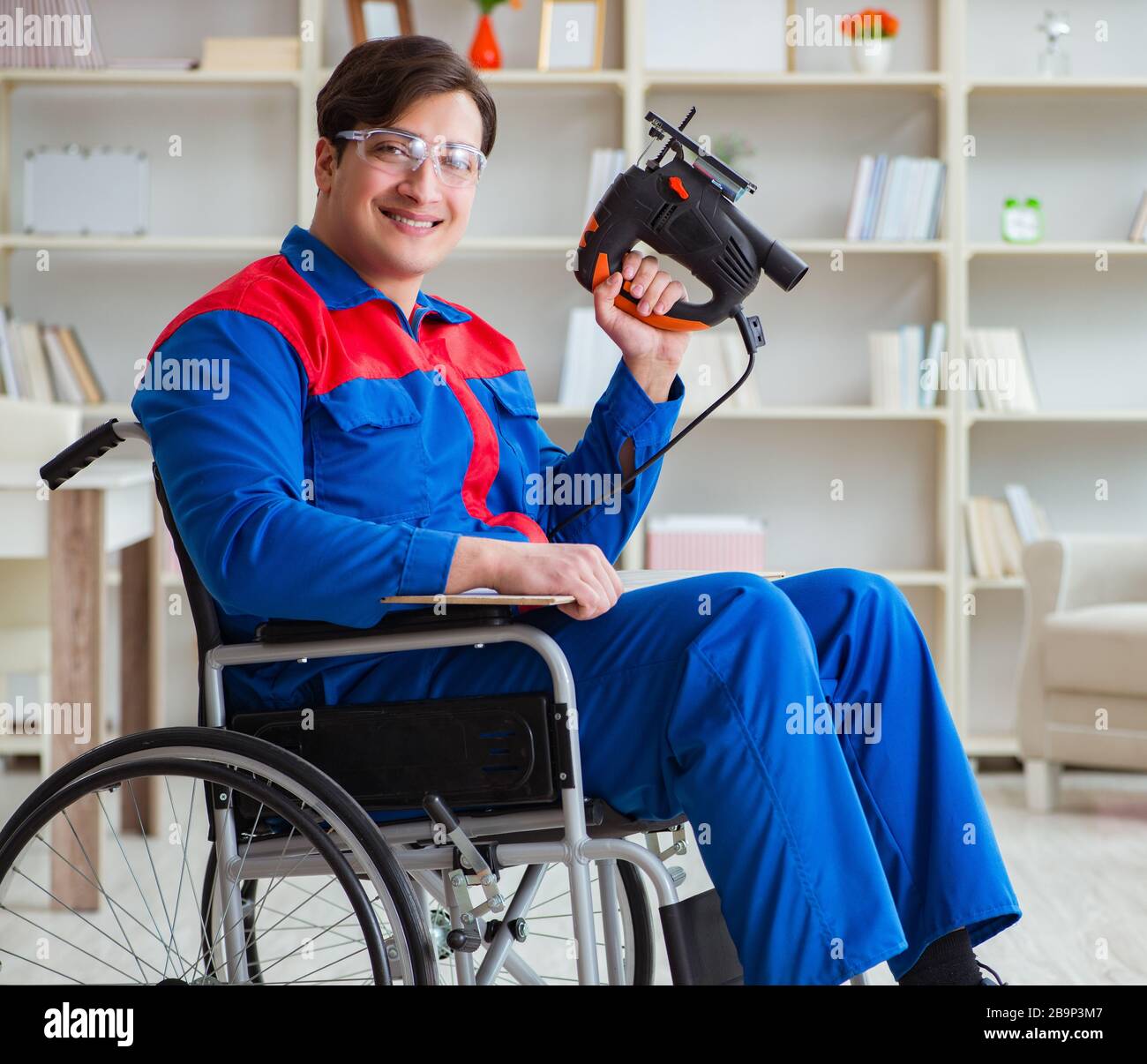 The disabled man working with handsaw at home Stock Photo - Alamy