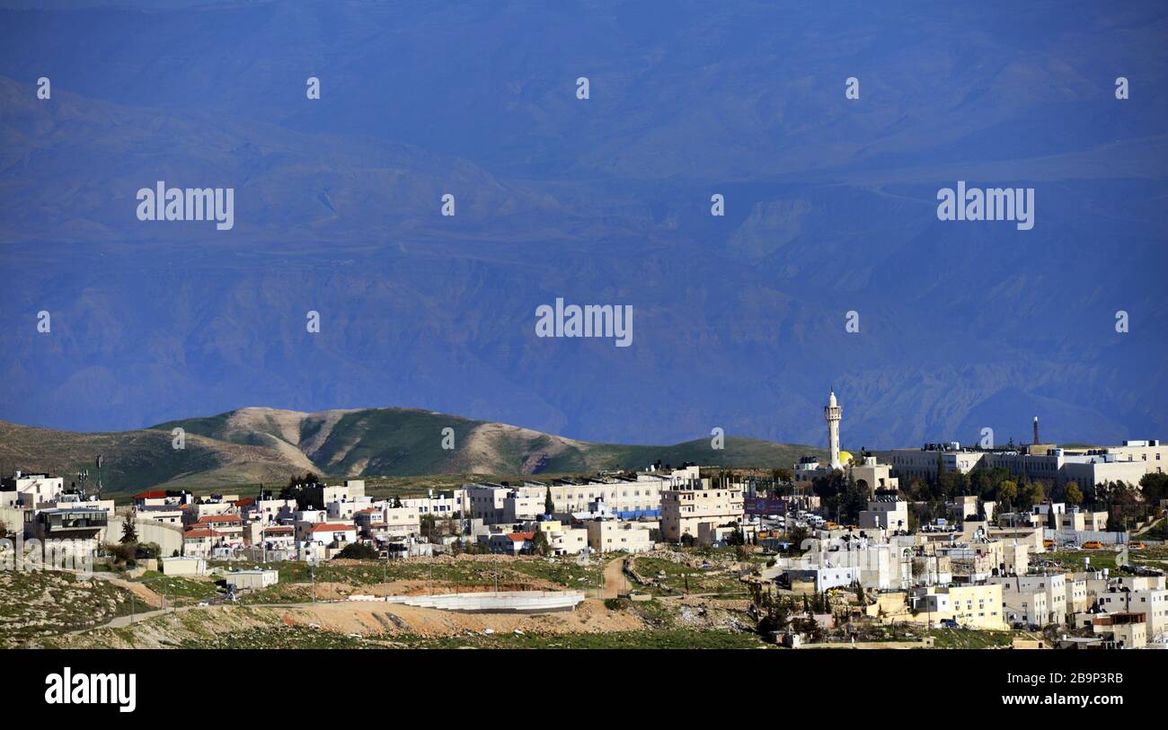 A view of a Palestinian village with the mountains of Jordan in the ...