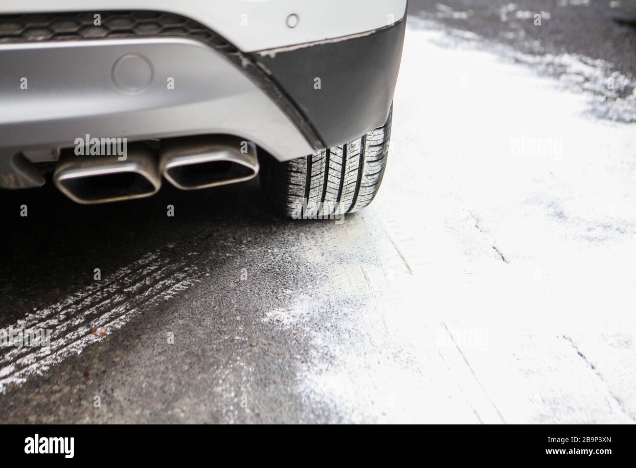 Car right back wheel in a snowy road with a tire track Stock Photo - Alamy