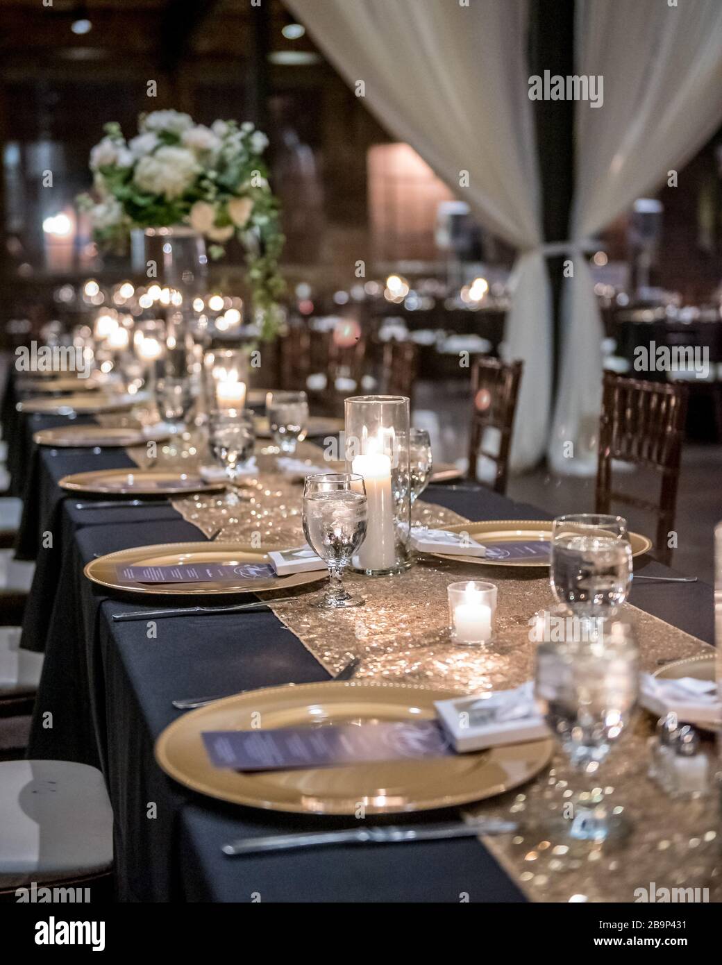 Vertical closeup shot of an elegant wedding table setting in the hall ...