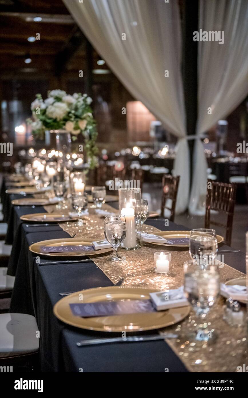 Vertical closeup shot of an elegant wedding table setting in the hall ...